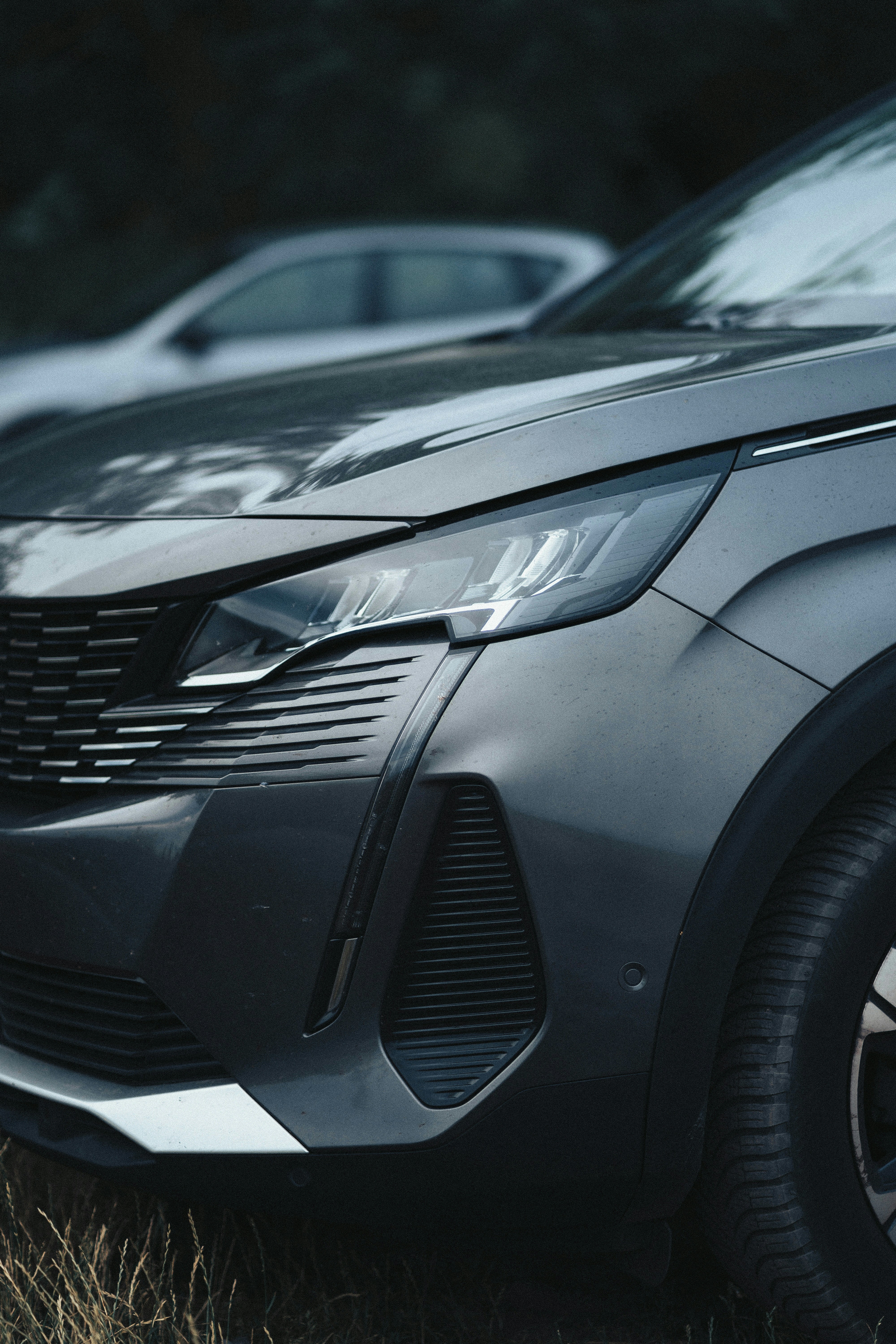 Close-up of a modern SUV's aggressive front fascia and headlight detail