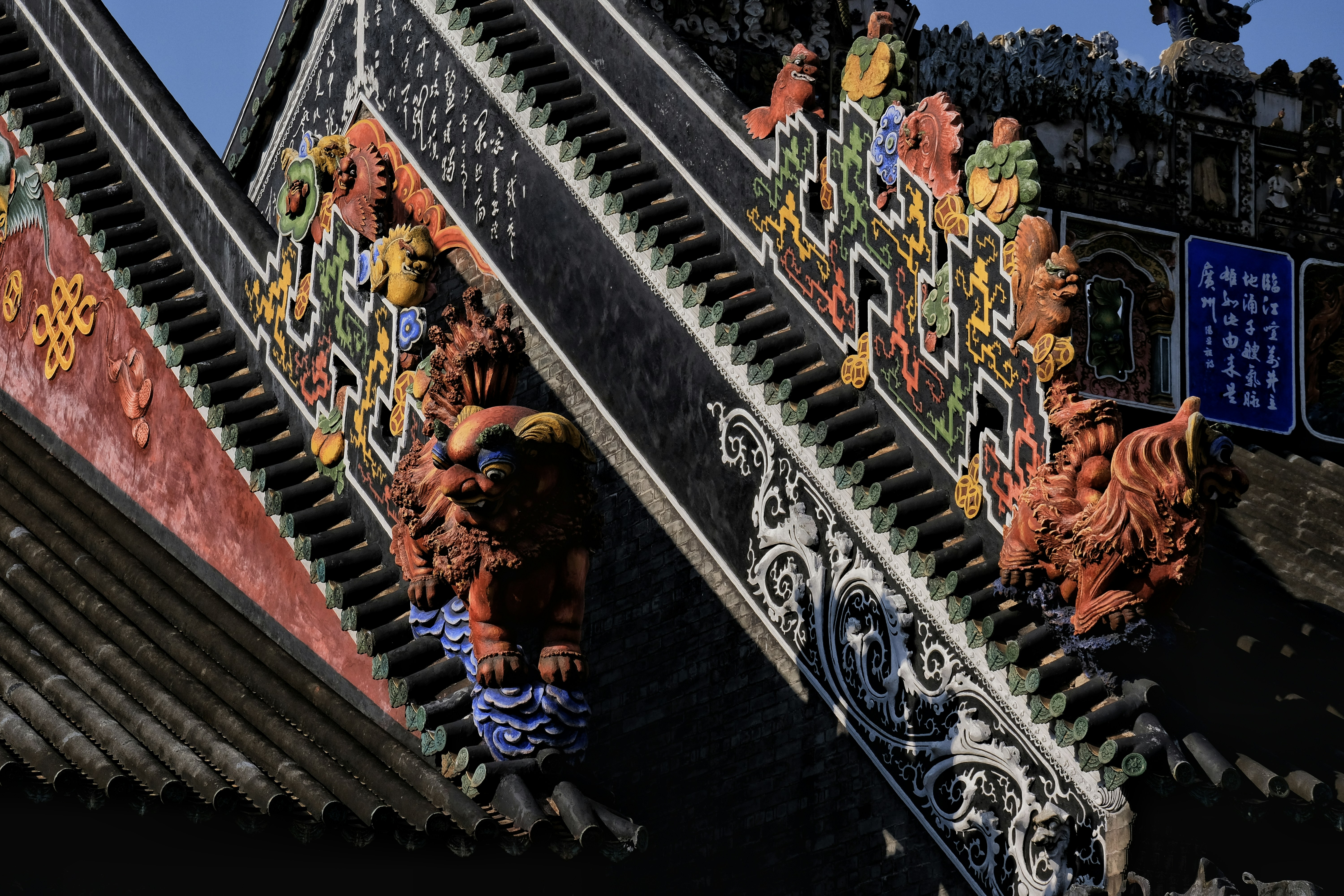 Dragon-carved rooflines and ornate eaves rising along a temple wall