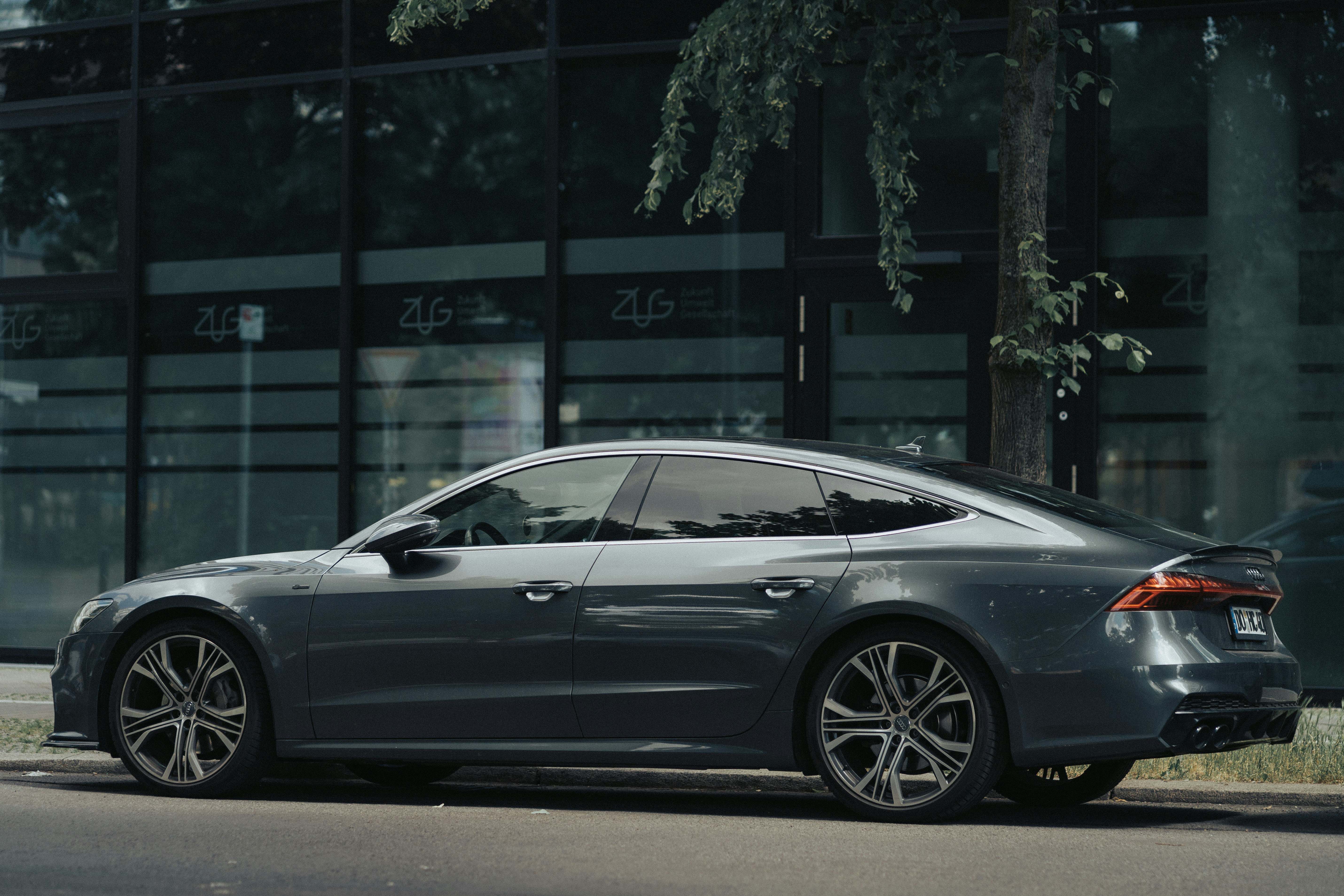 Sleek Shadow: A Slate-Blue Coupe Parked Along a Quiet Street