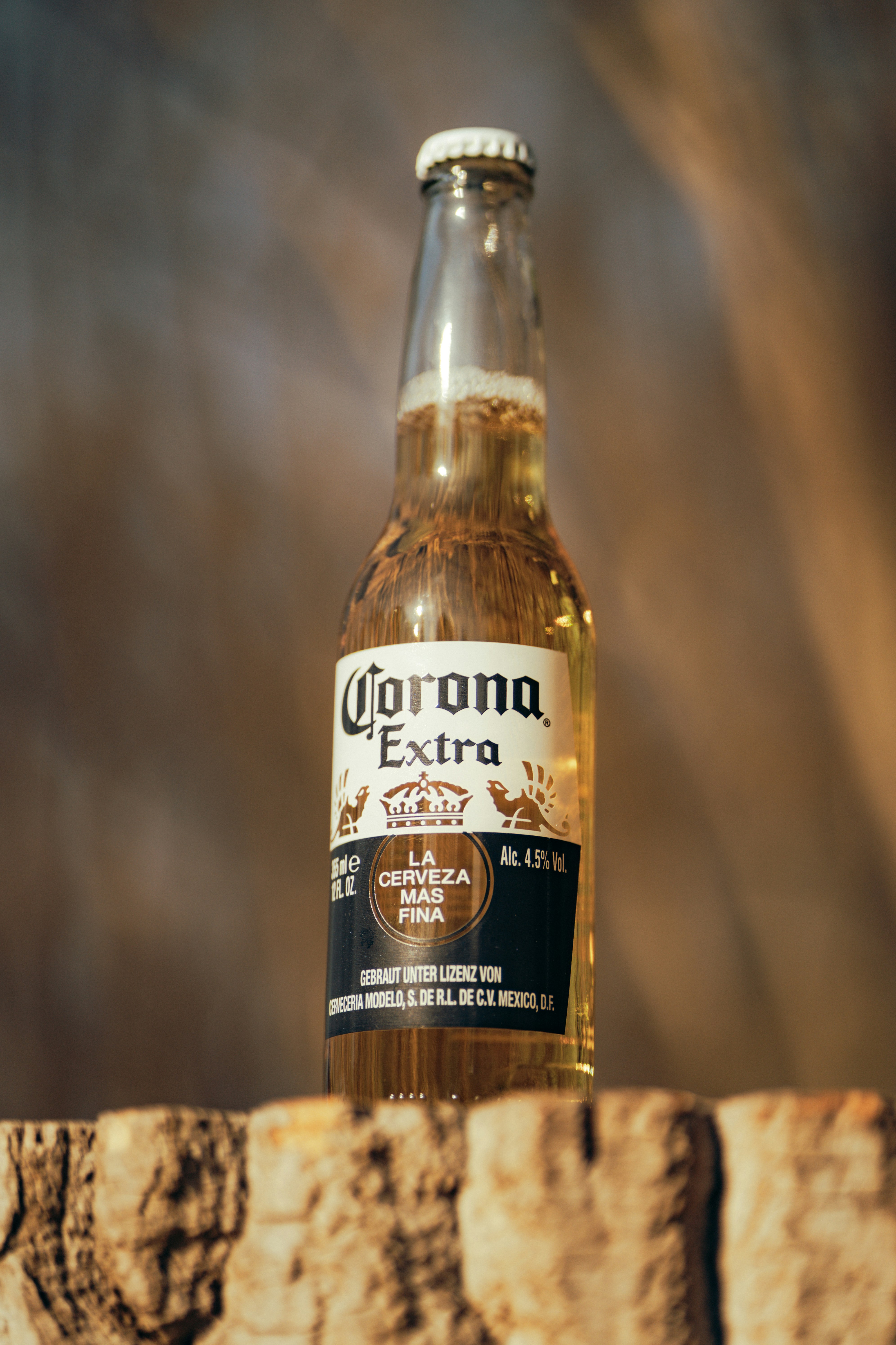 Corona on the Edge: A Bottle in Focus on a Weathered Wood Stage