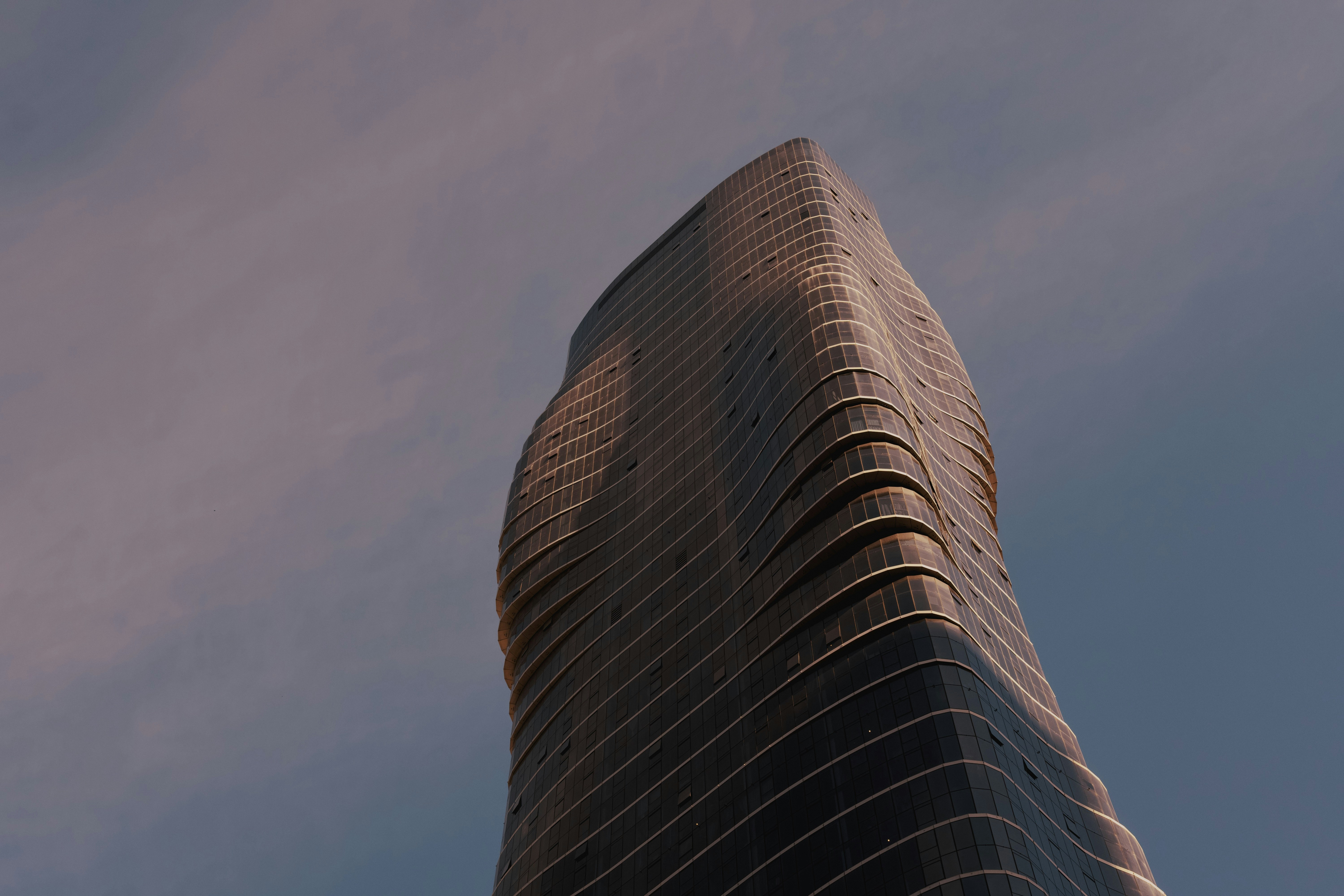Rising Glass: A Skyscraper Pierced by Evening Light