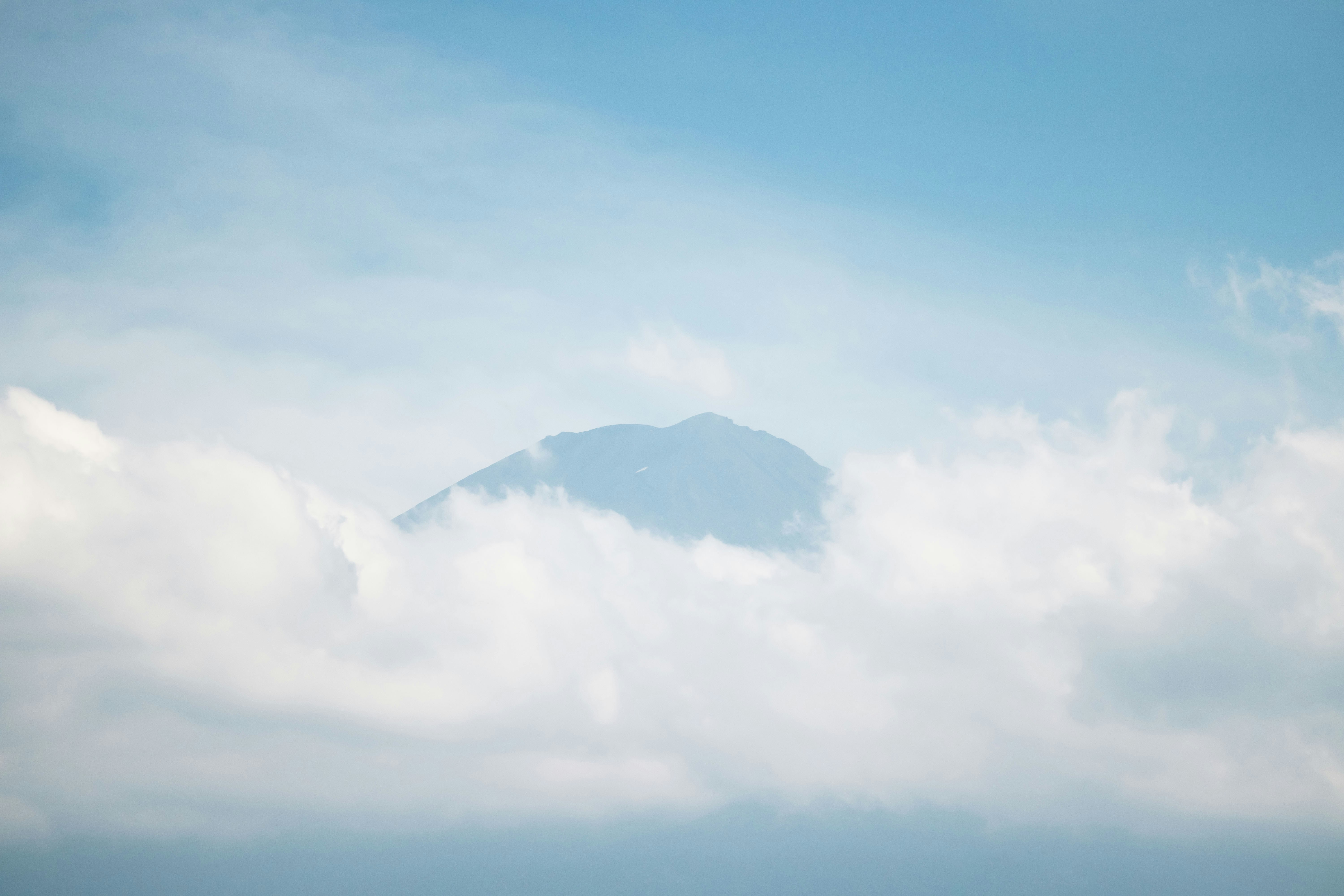 Mist-veiled Peak: A Gentle Rise Above the Clouds