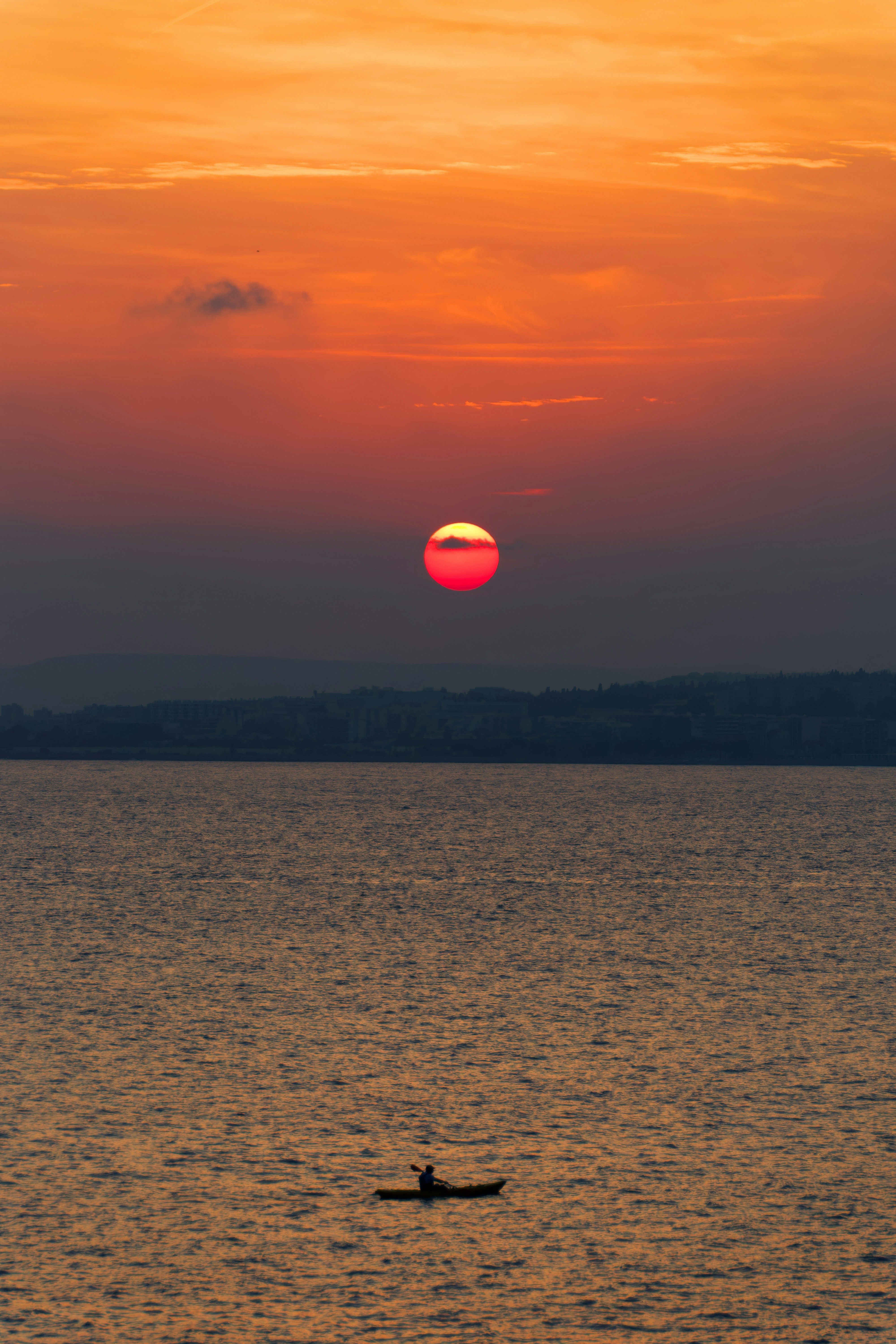 Horizon's Red Pearl: Sunset Over Quiet Waters