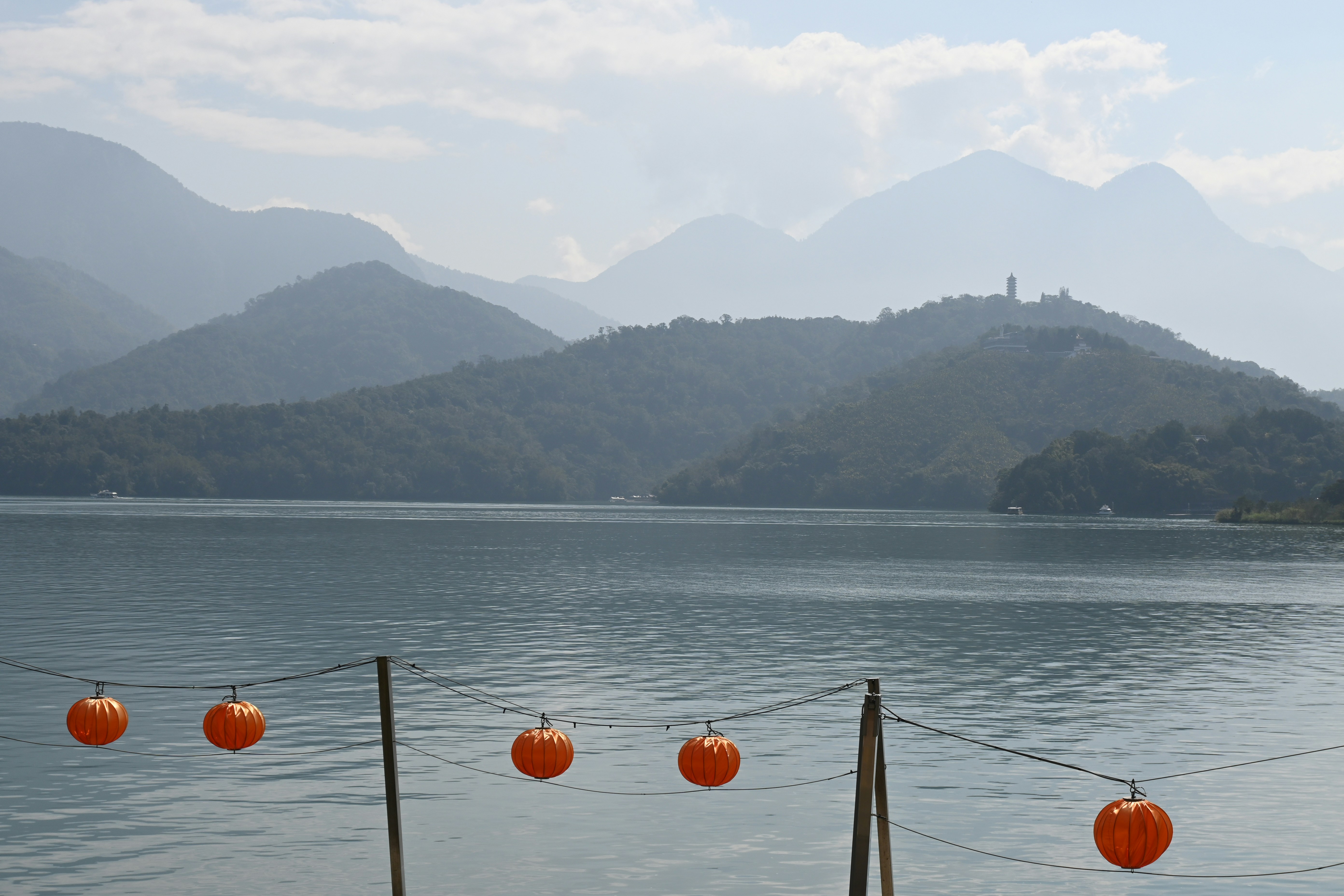 Mist on the Hills Over Lake with Floating Lanterns