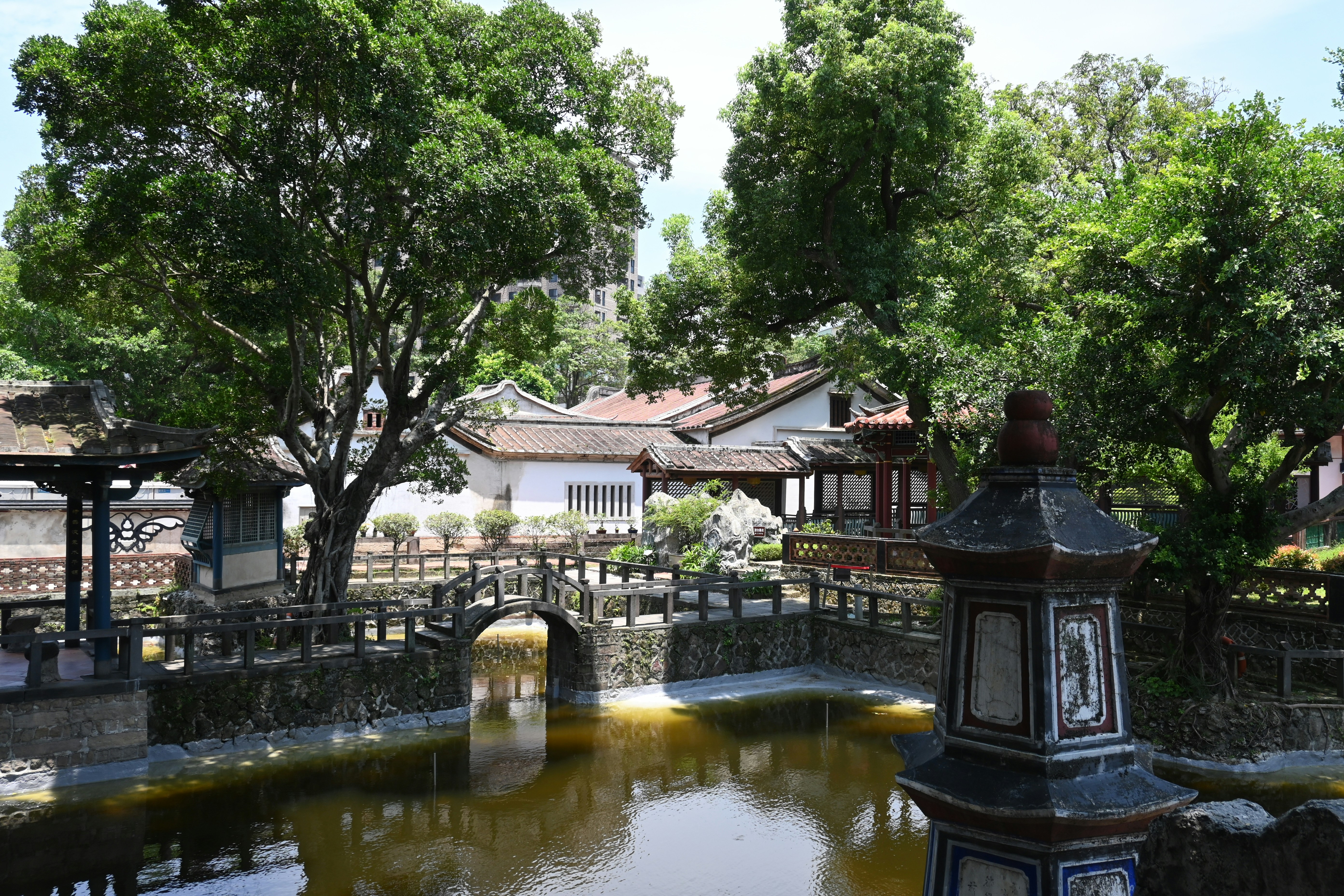 Serene Chinese garden with arched bridge and pagoda by still pond