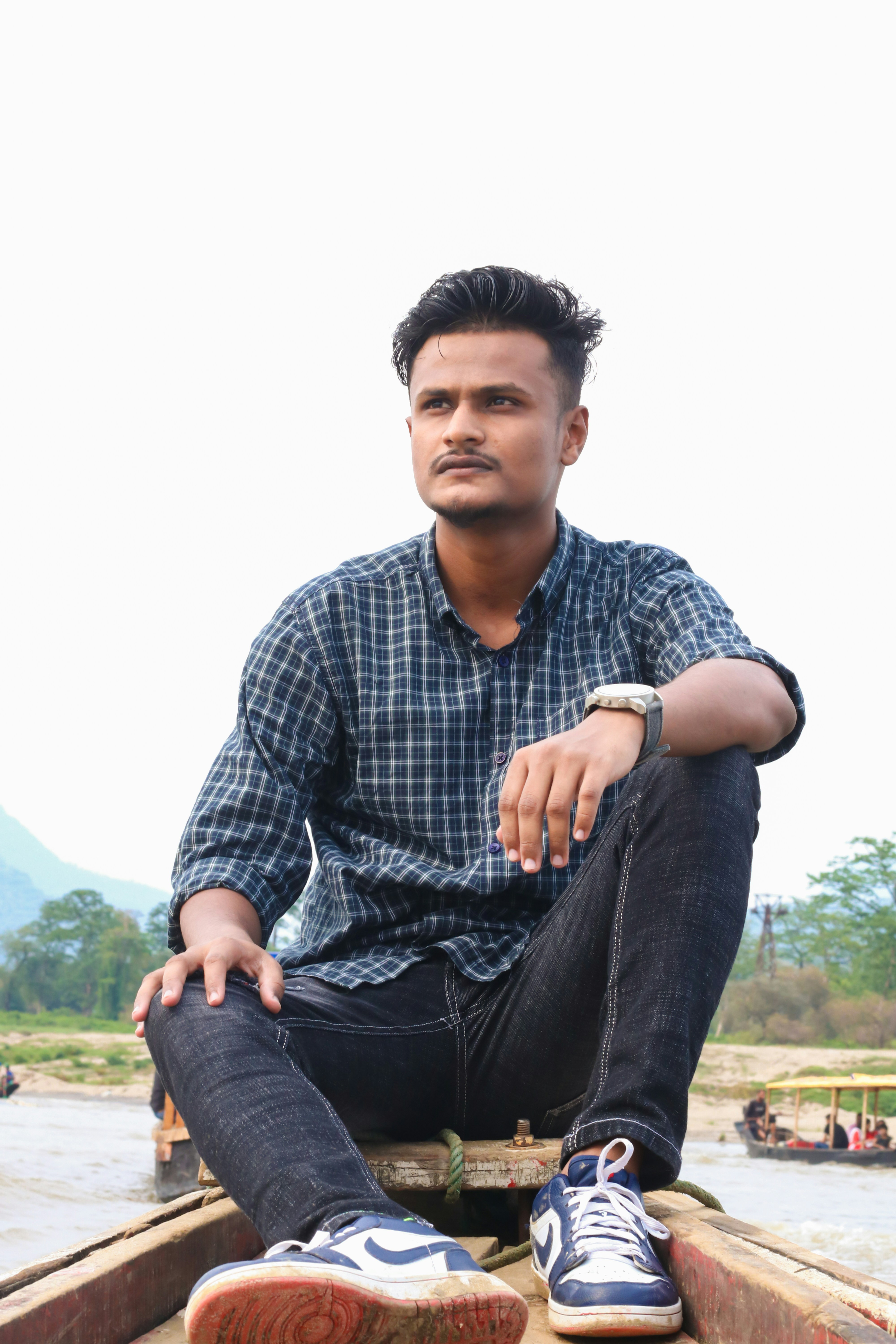 Wary Quietude: A Seated Moment on the Riverbank