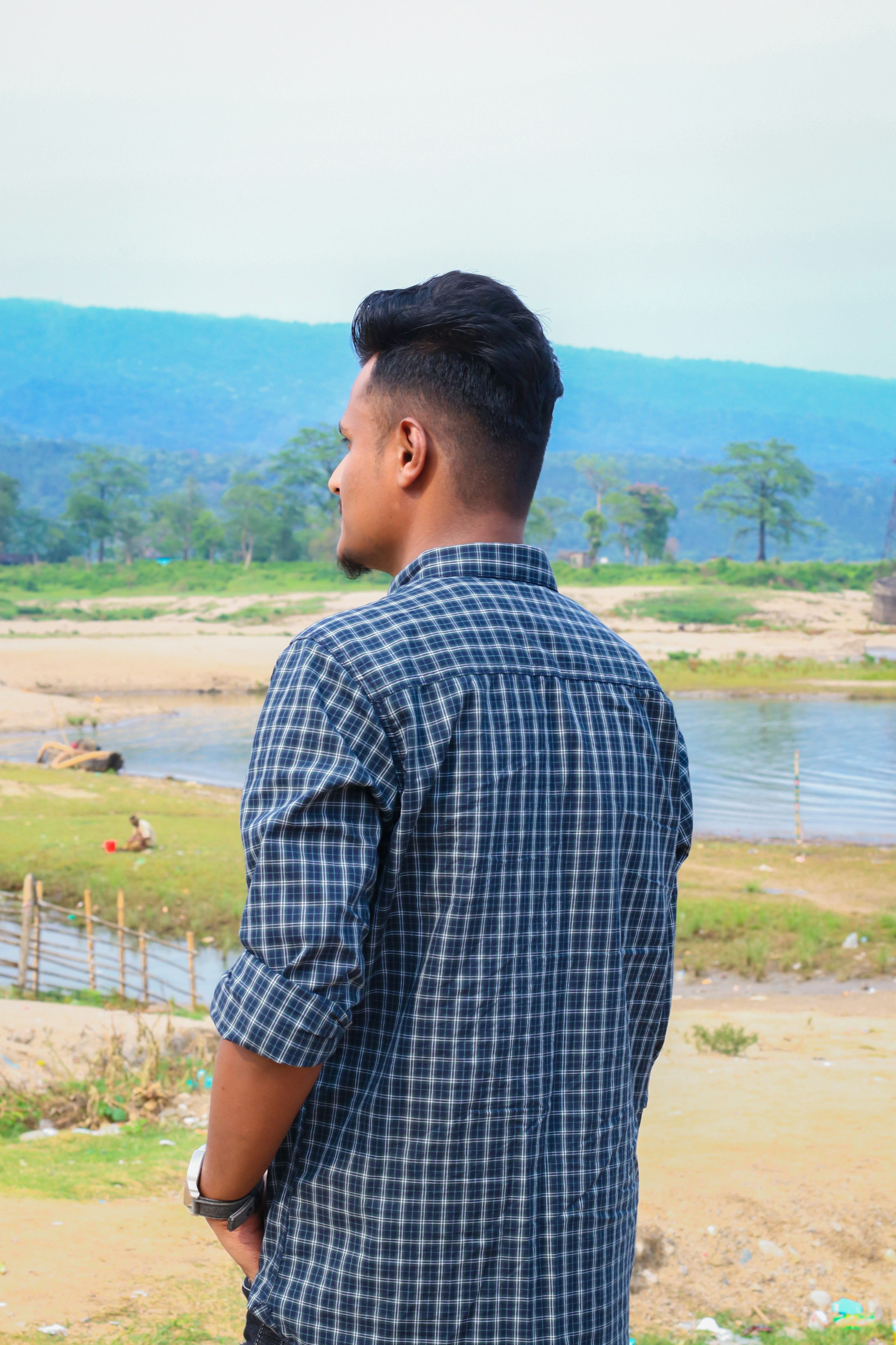 Side Profile at the Riverside: A Quiet Portrait with a Distant Horizon