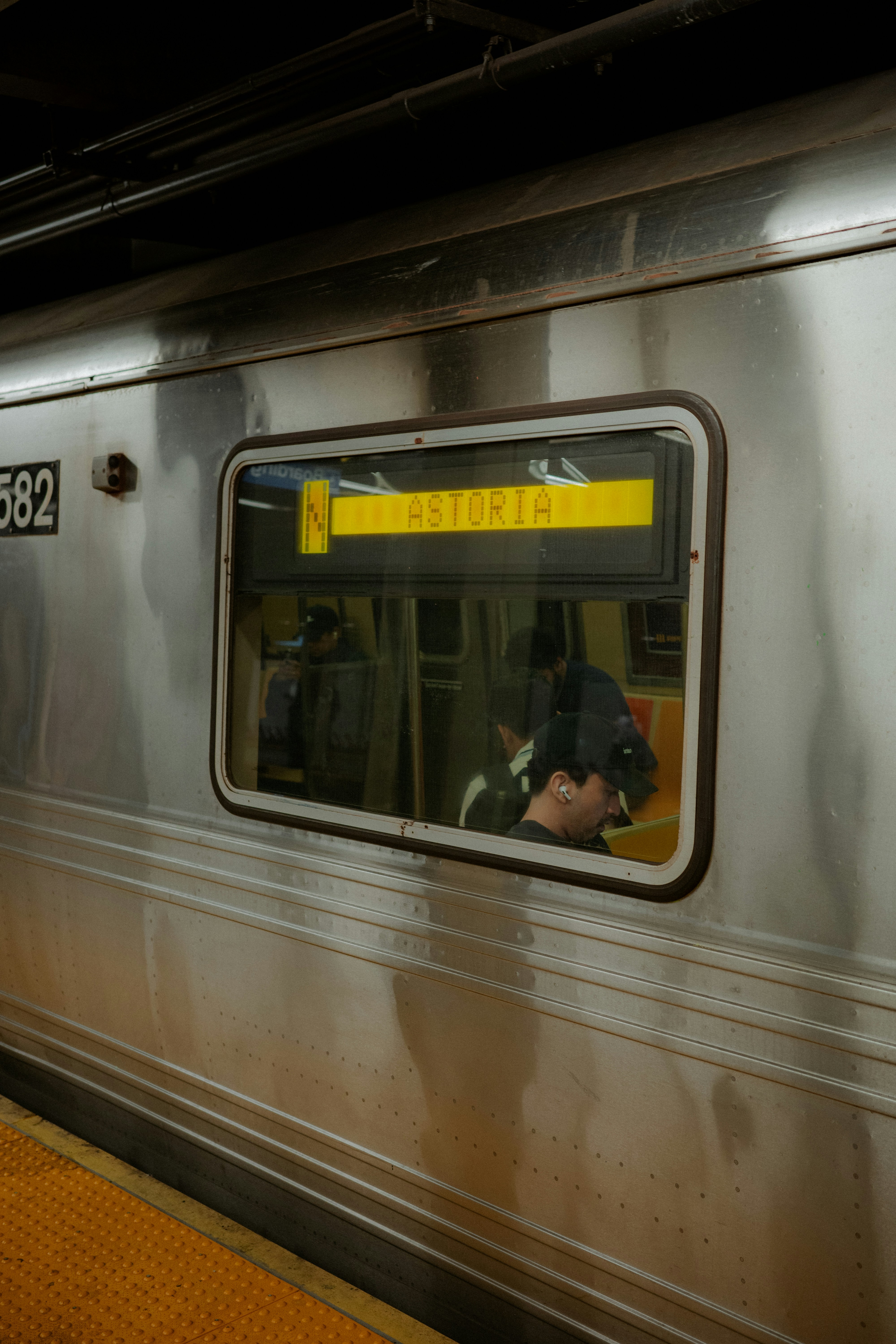 Subway Window: A Quiet Moment Inside a Vibrant Car