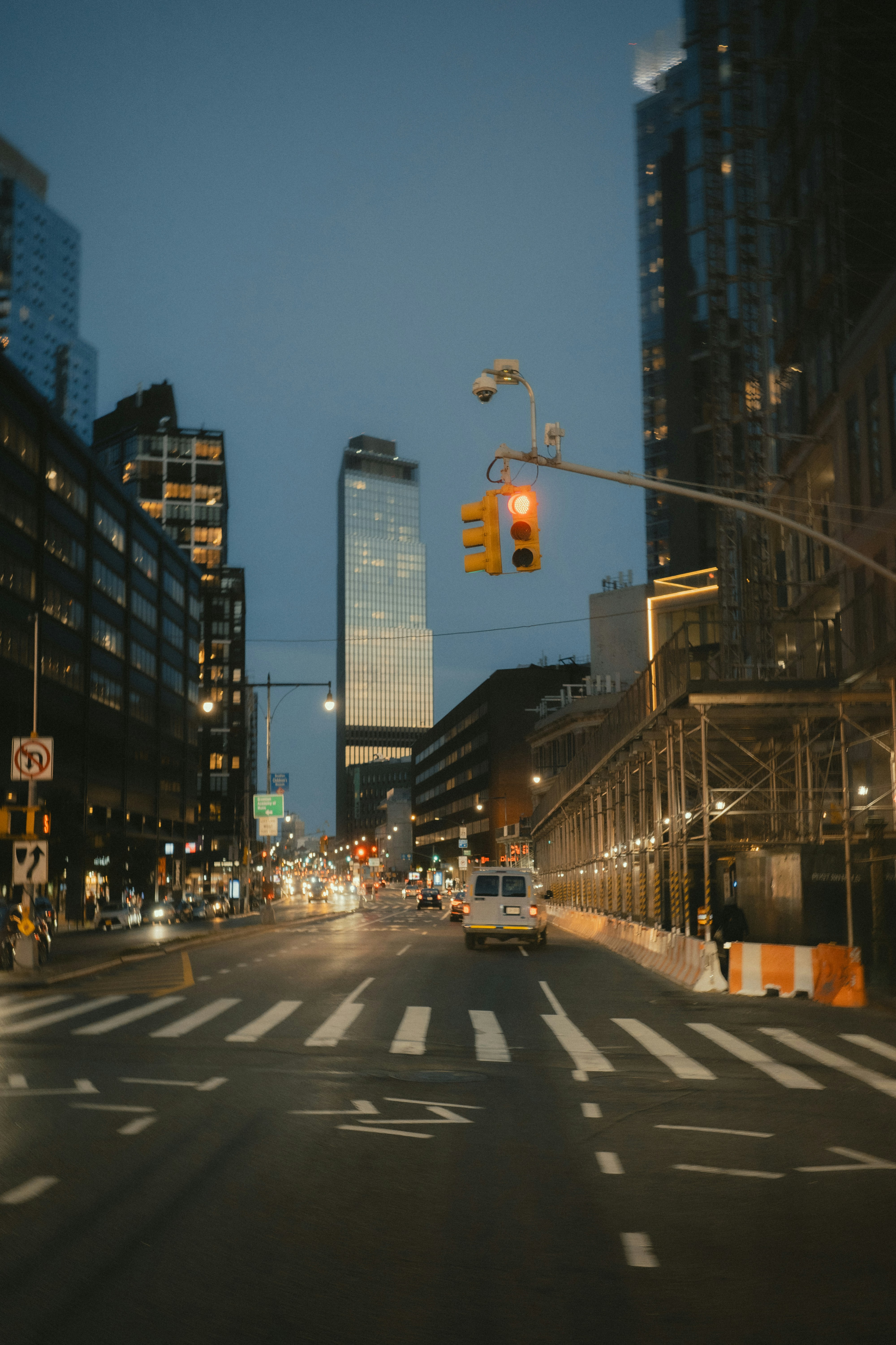 Urban Convergence: Street Lights and Skyline at Dusk