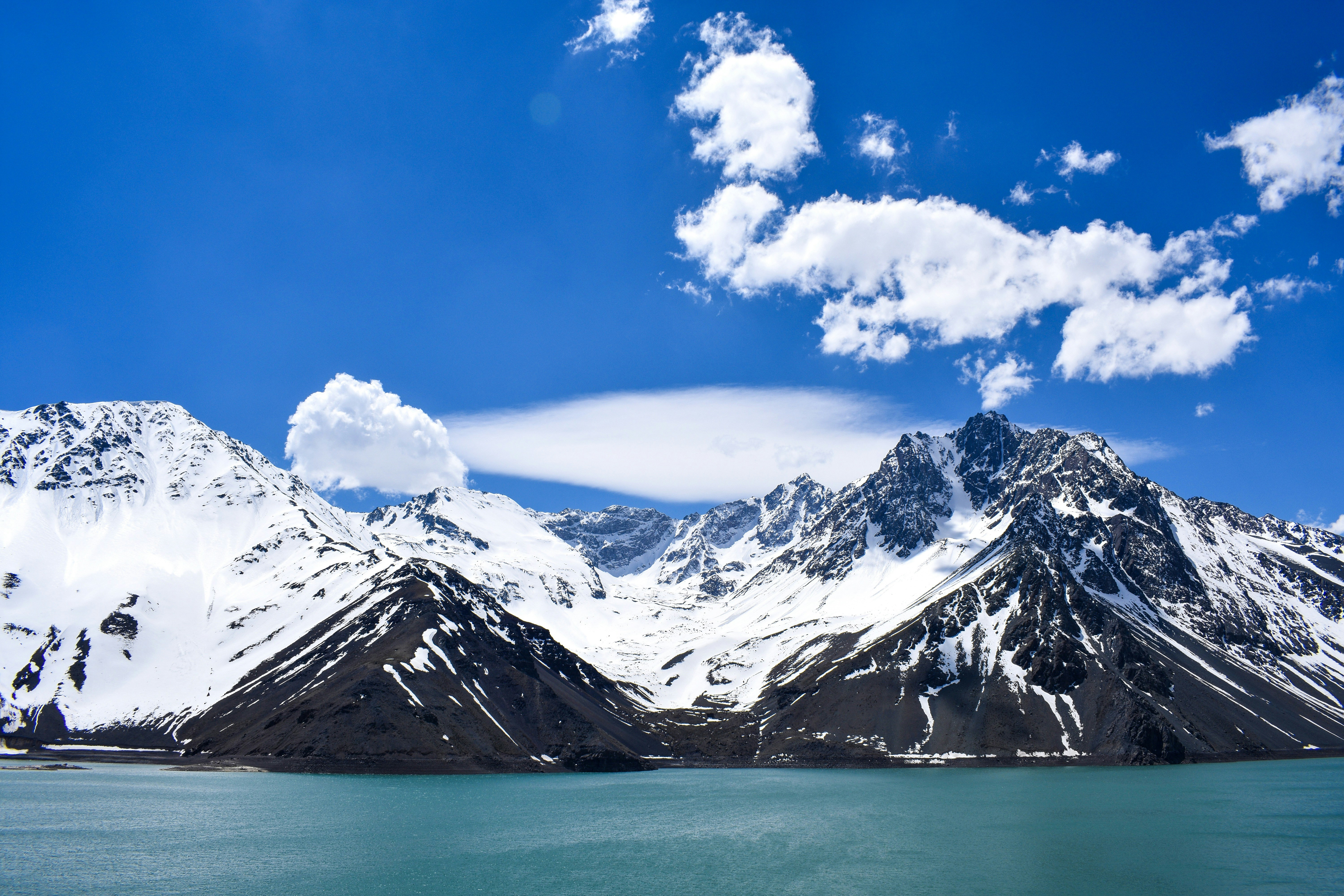 Snow-Dusted Peaks Over Turquoise Fjord