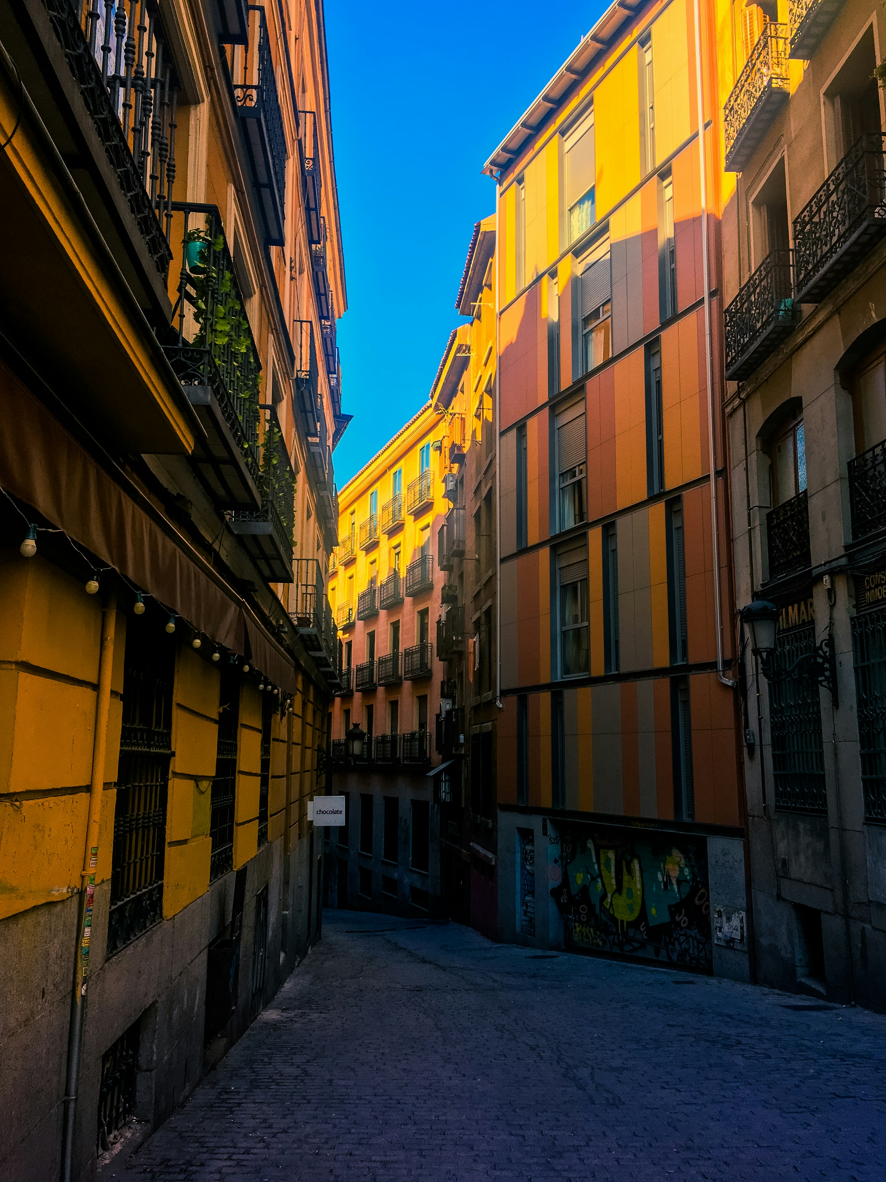 Sunlit Calle de Color: A Canyon of Buildings