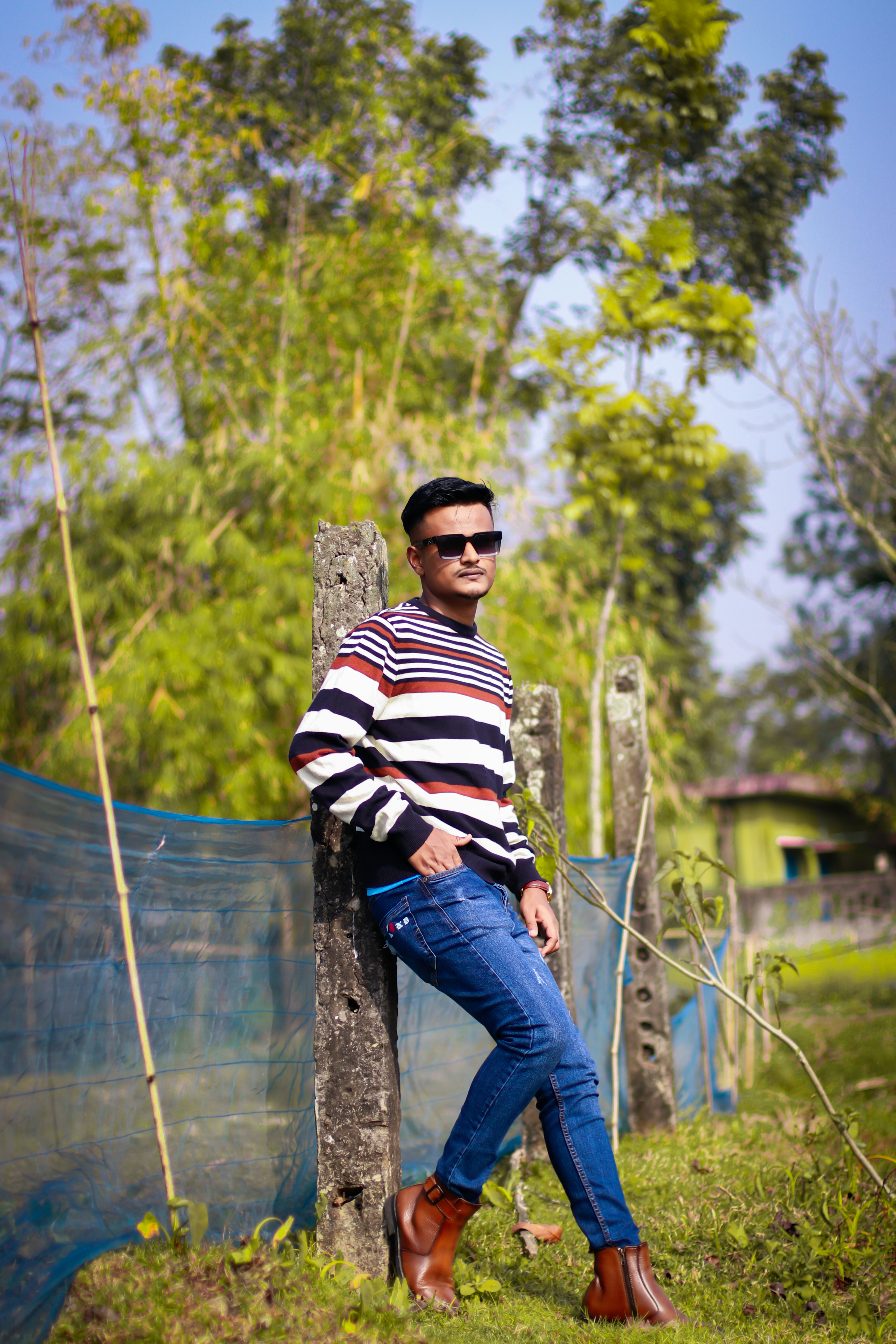 Leaning on a Weathered Post: a Casual Portrait in Dappled Light
