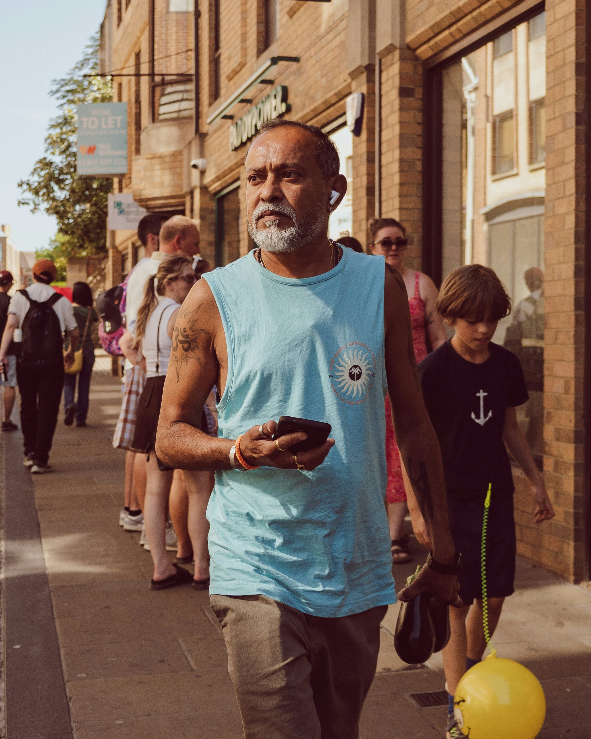 Street Portrait: A Moment of Focus Amid City Buzz