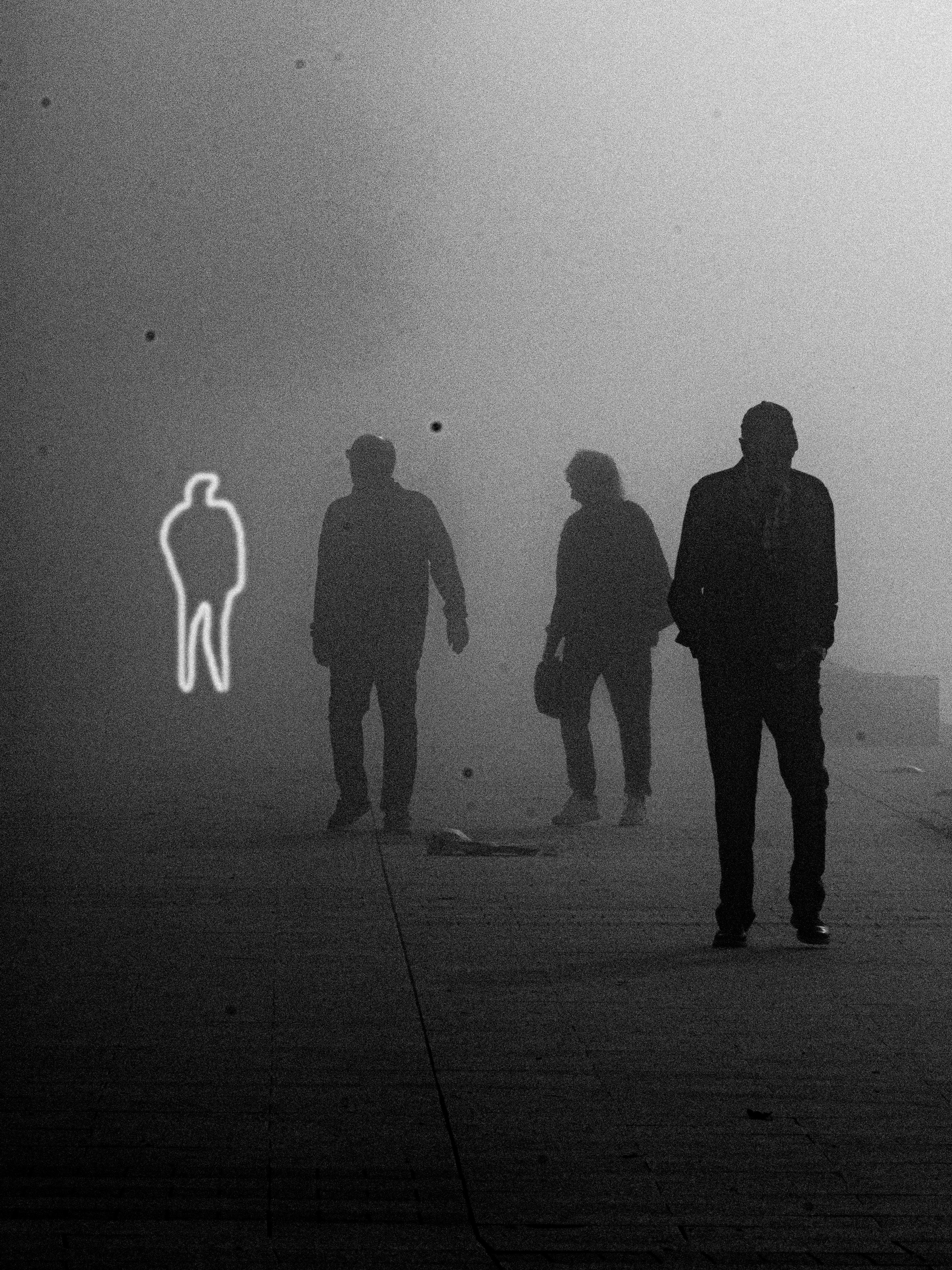 Shadowed Quartet on a Fogbound Pier