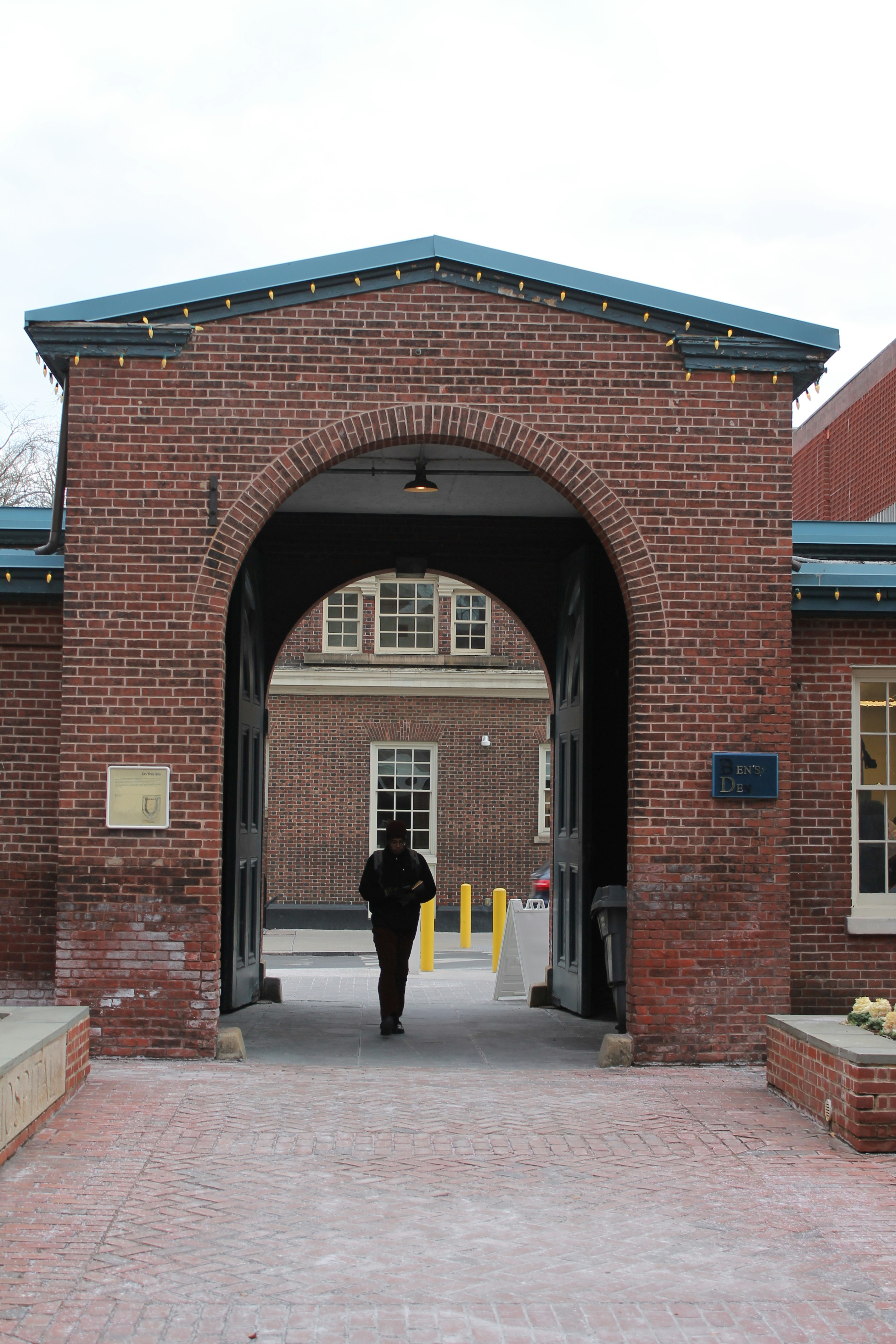 Brick Archway Crossing: A lone figure under the gateway