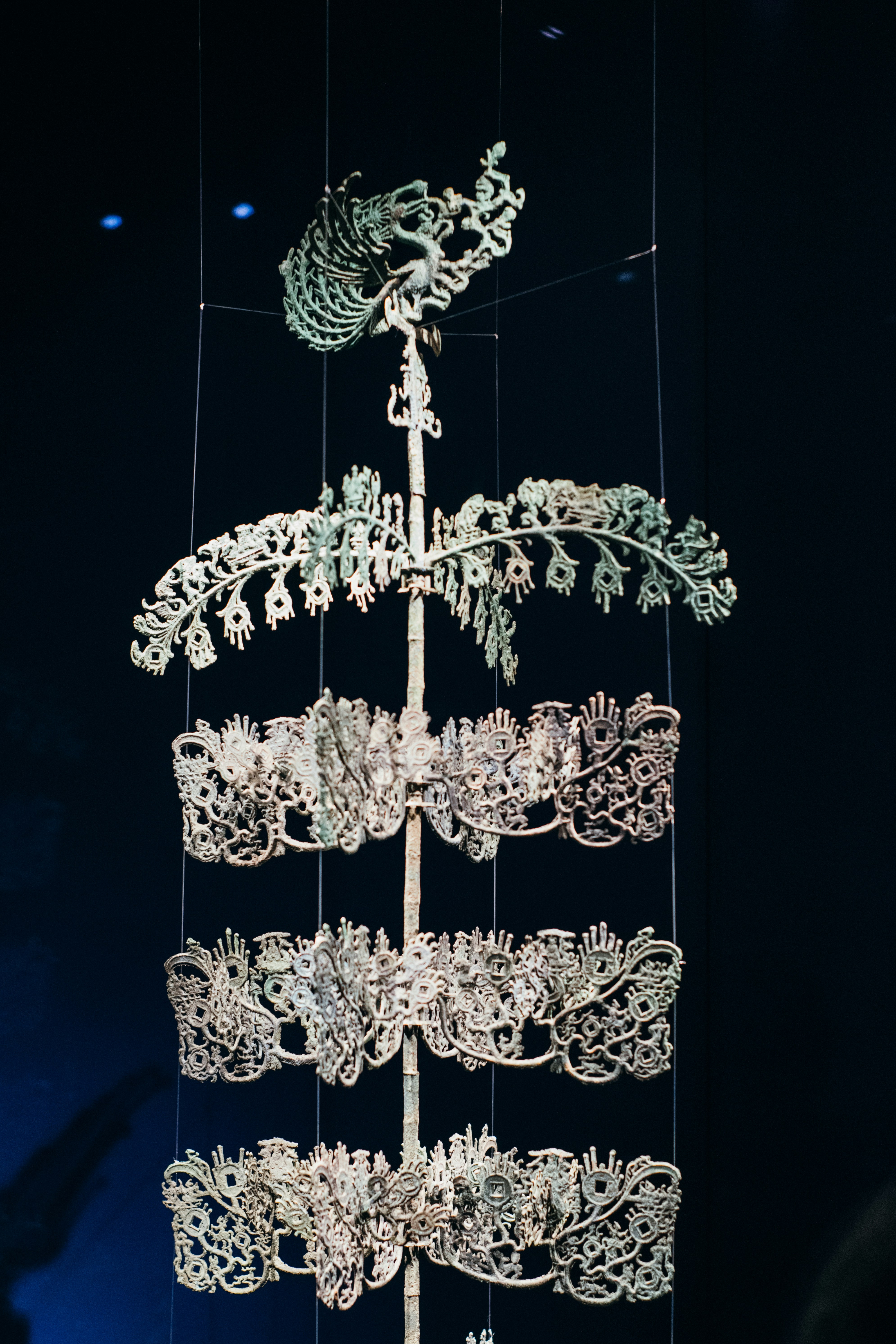 Ornate Hanging Lace Tower under Dim Gallery Lights