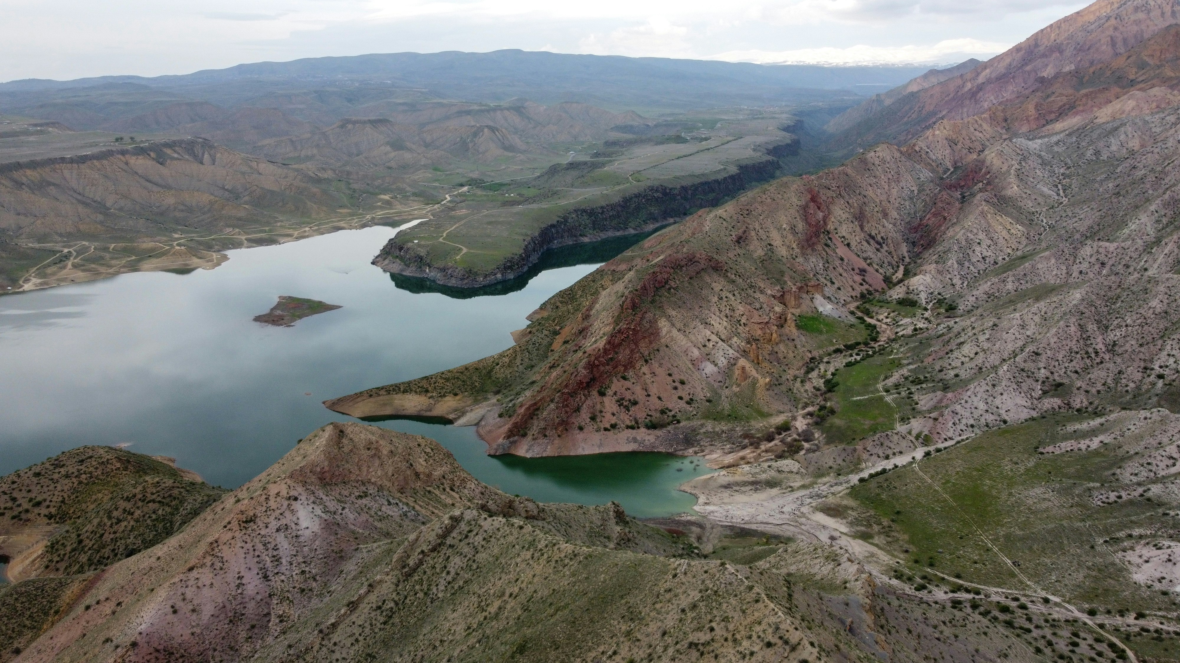 Aerial Confluence: Terraced Hills and Serene Reservoir