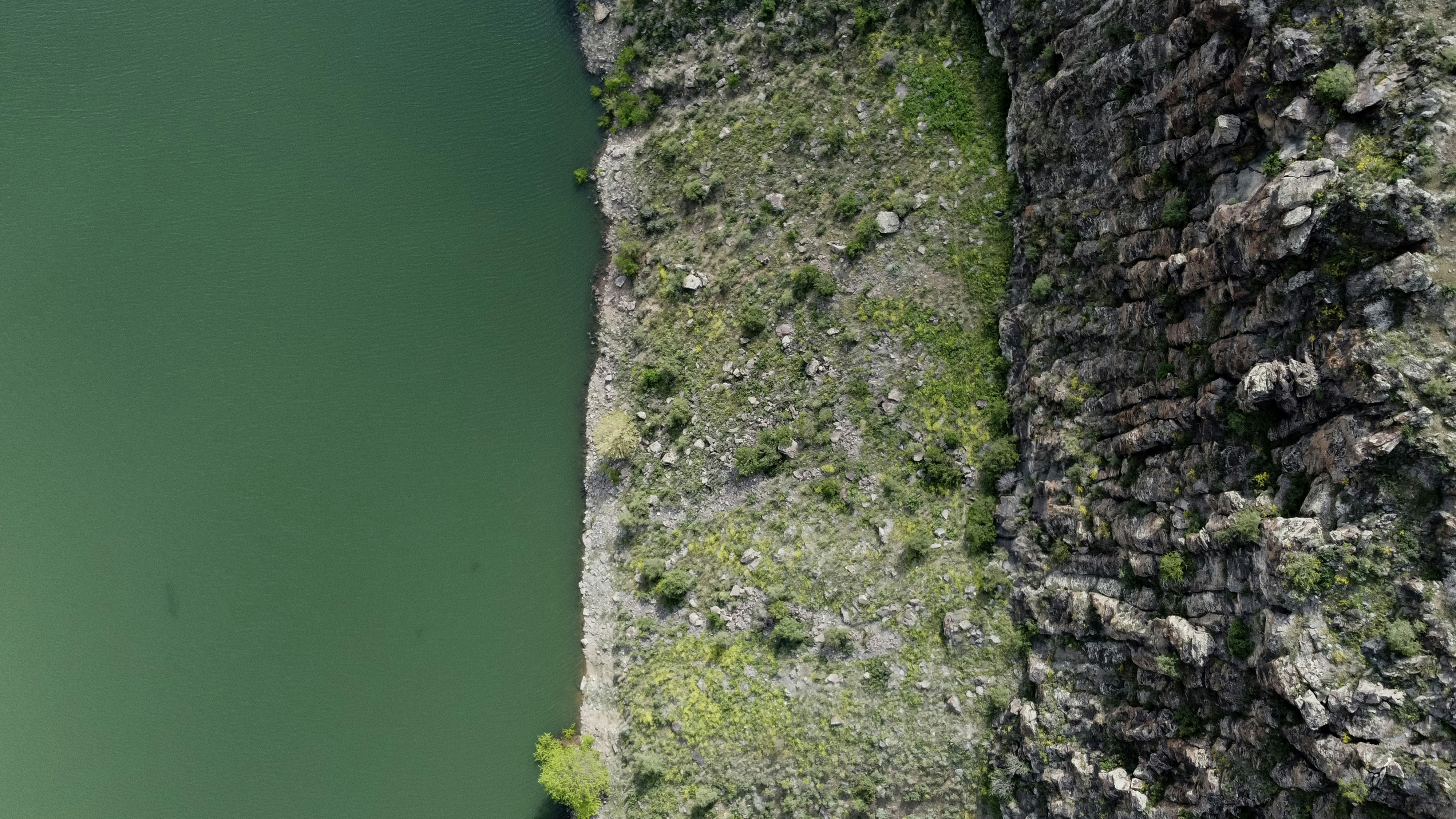 Edge of the Stone Cliff and Shaded Water