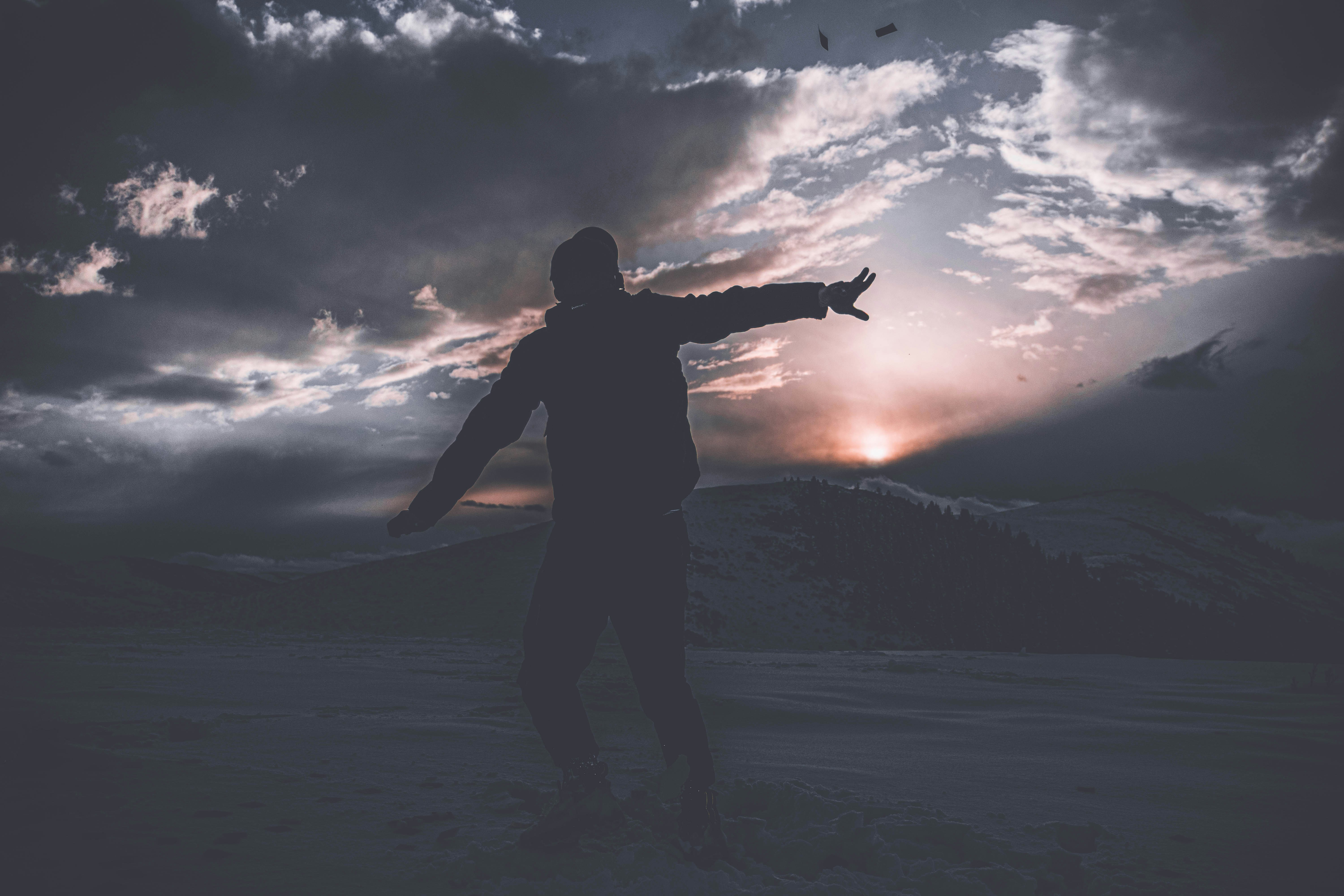 Silhouette in the Sunset: A figure at the edge of a frosted horizon