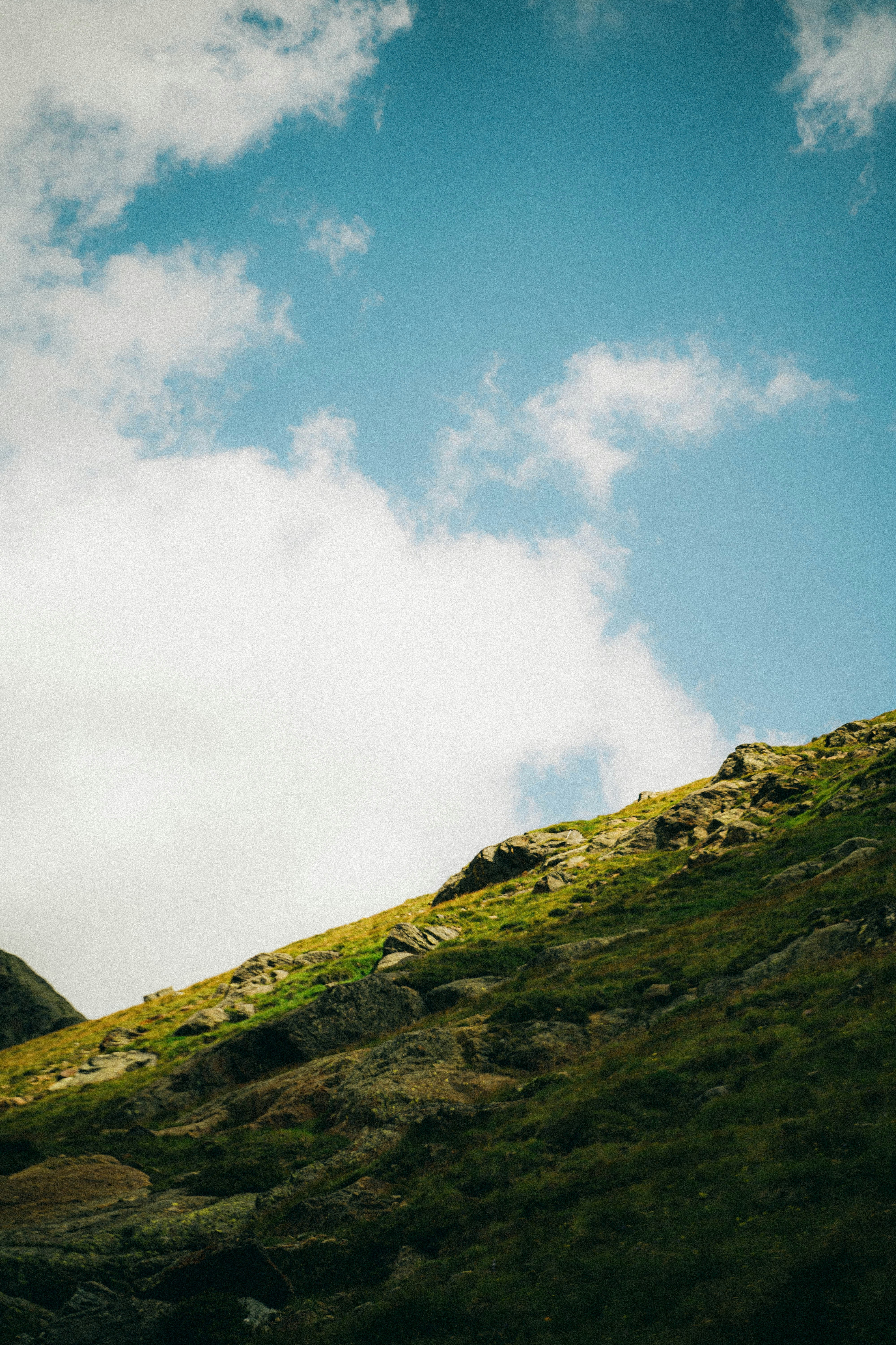 Slope of Quiet Sky: A Golden Peak Under Blue Veil