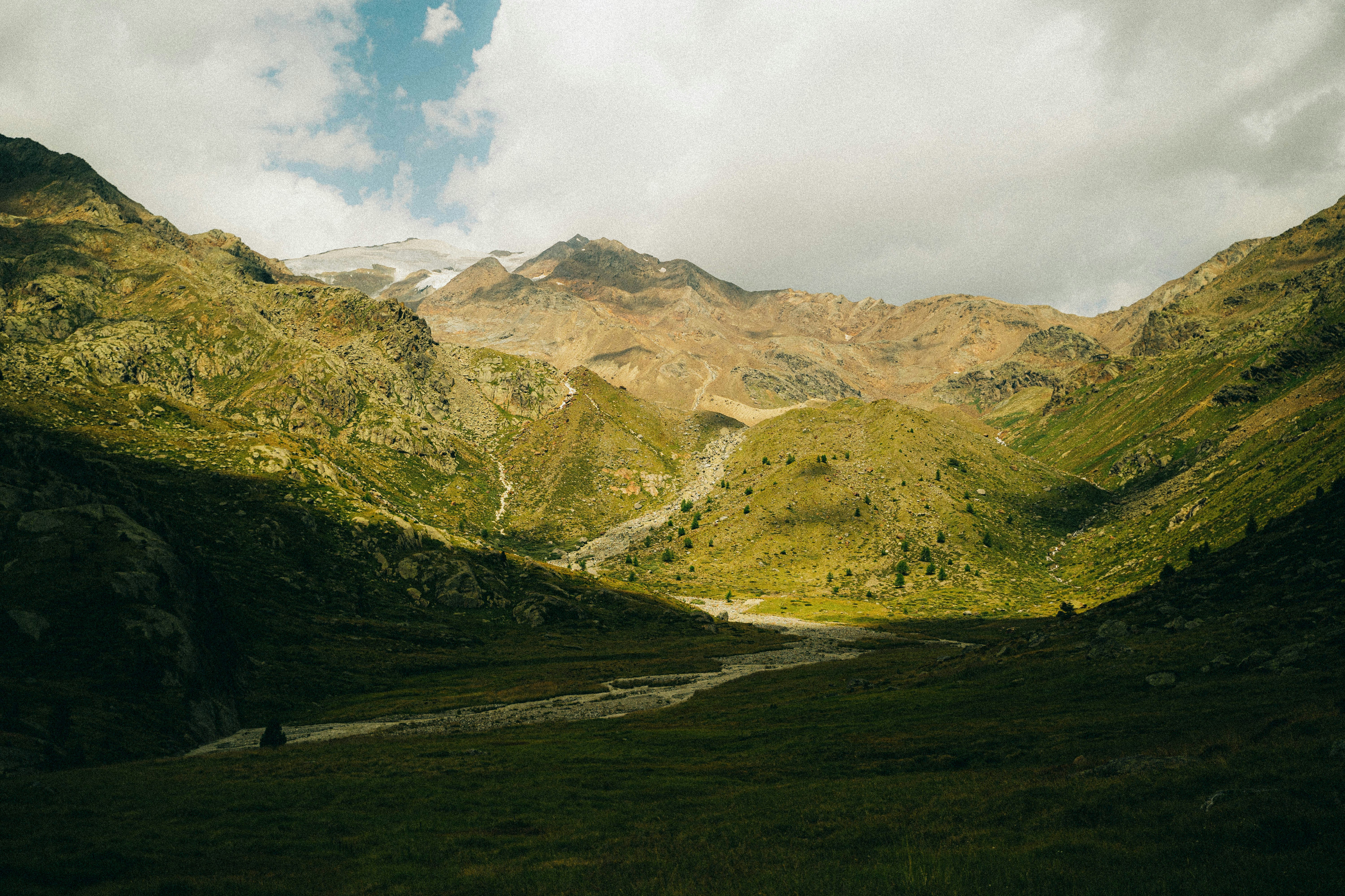 Sunlit Basin Amidst Rugged Peaks