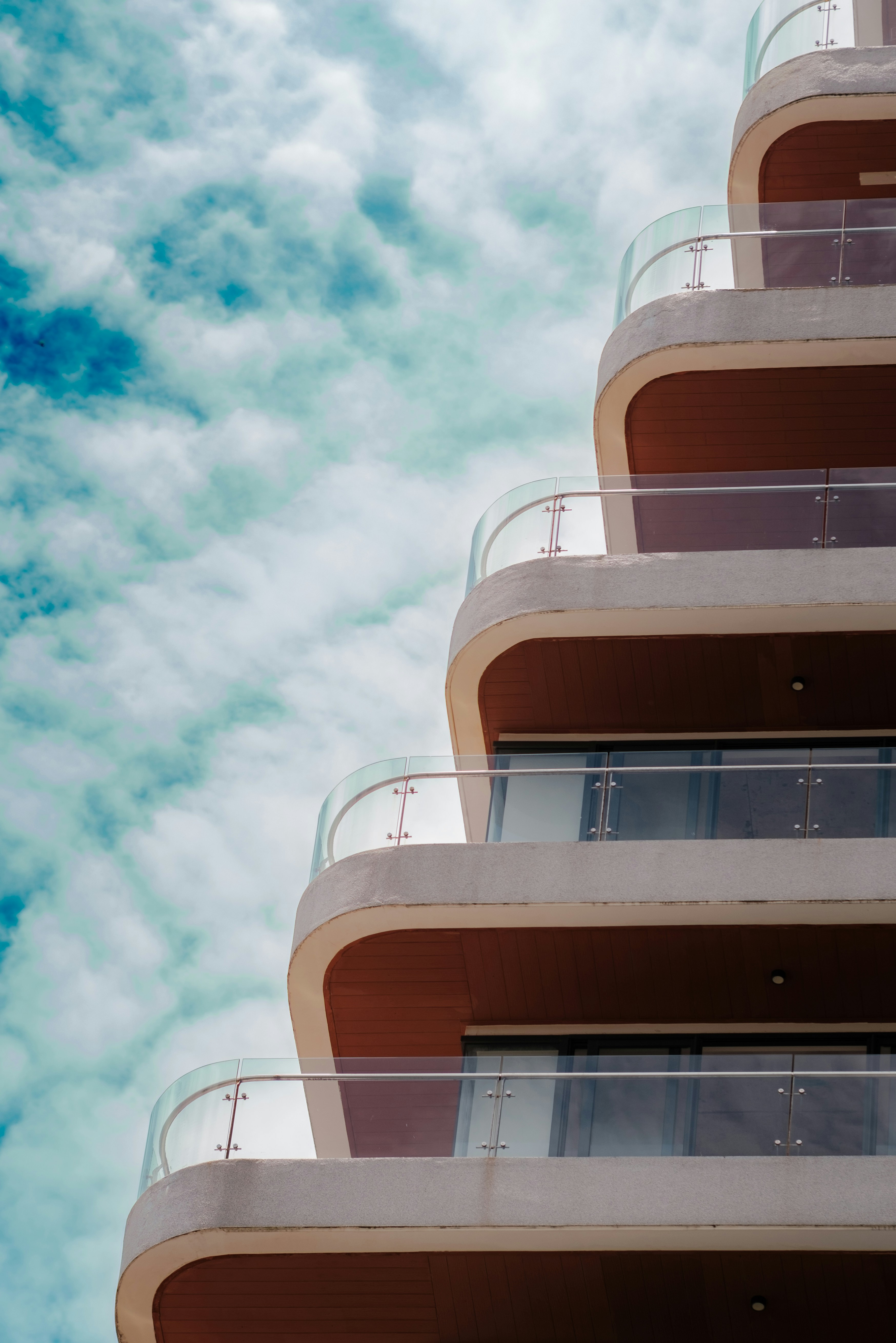 Balconies in Balance: Vertical Curves Against a Sky Canvas