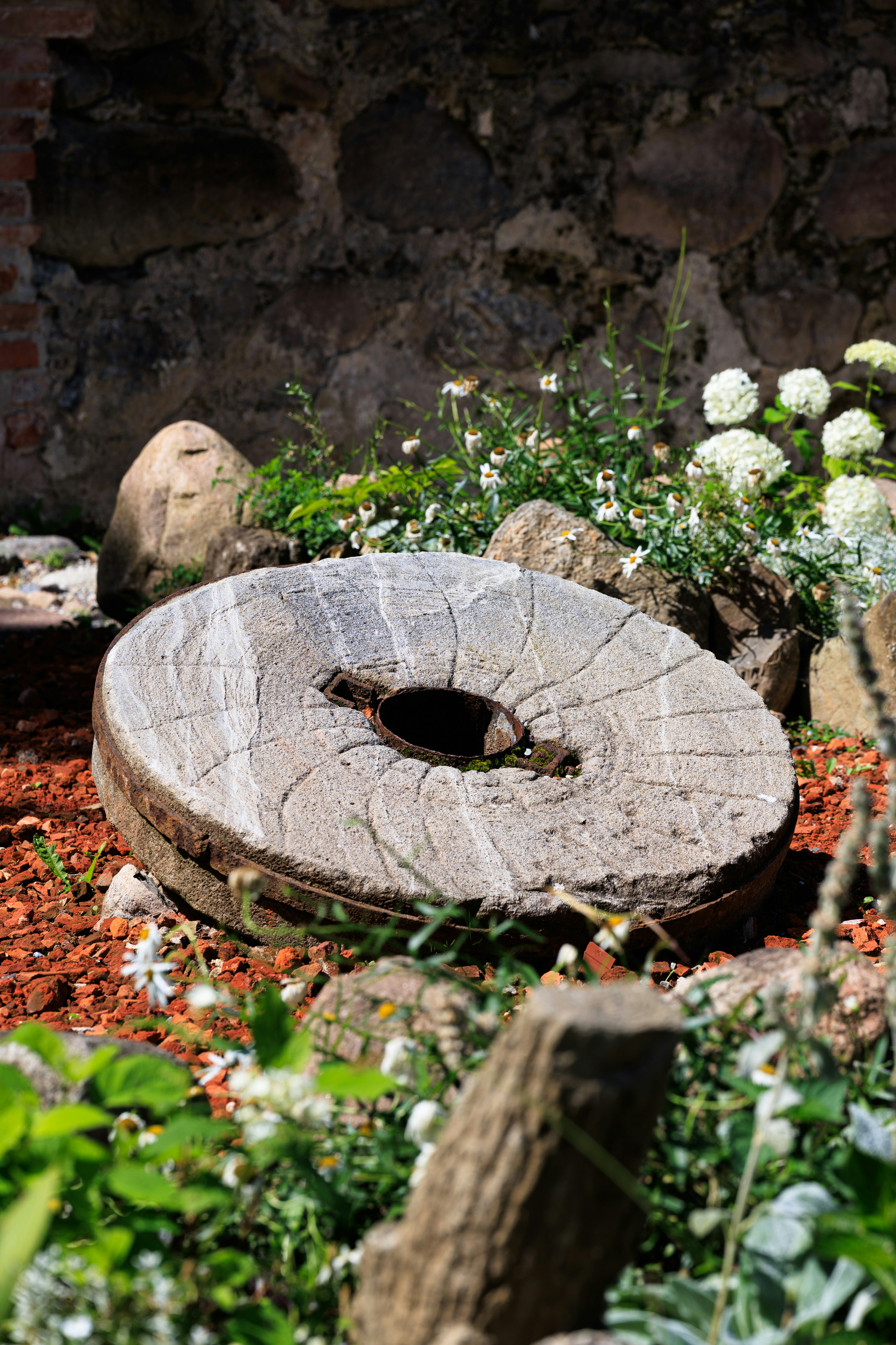 Circular Stone Wheel in a Mediterranean Garden Bed