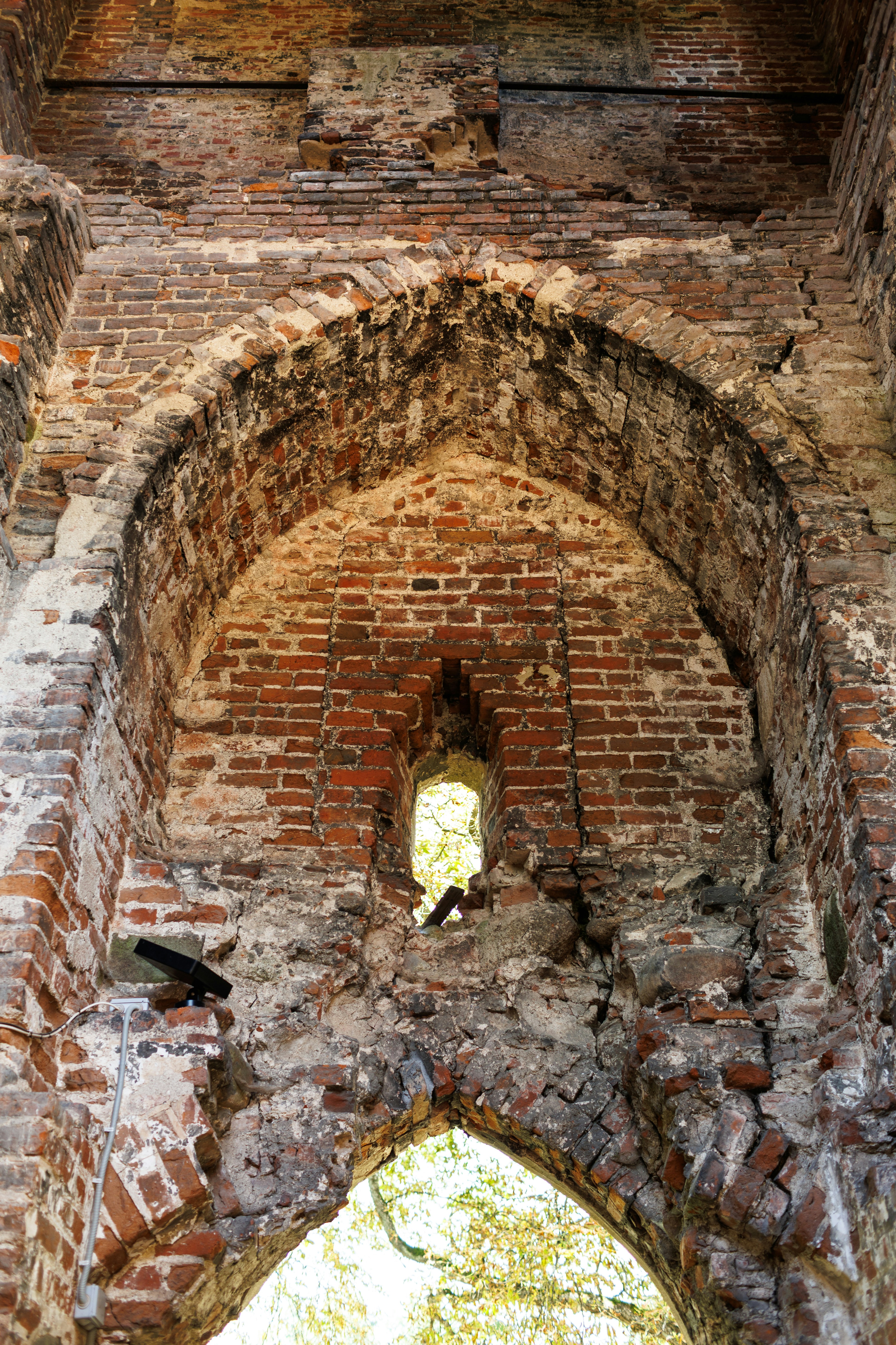 Ruined Brick Archway Revealing a Glint of Light Beyond