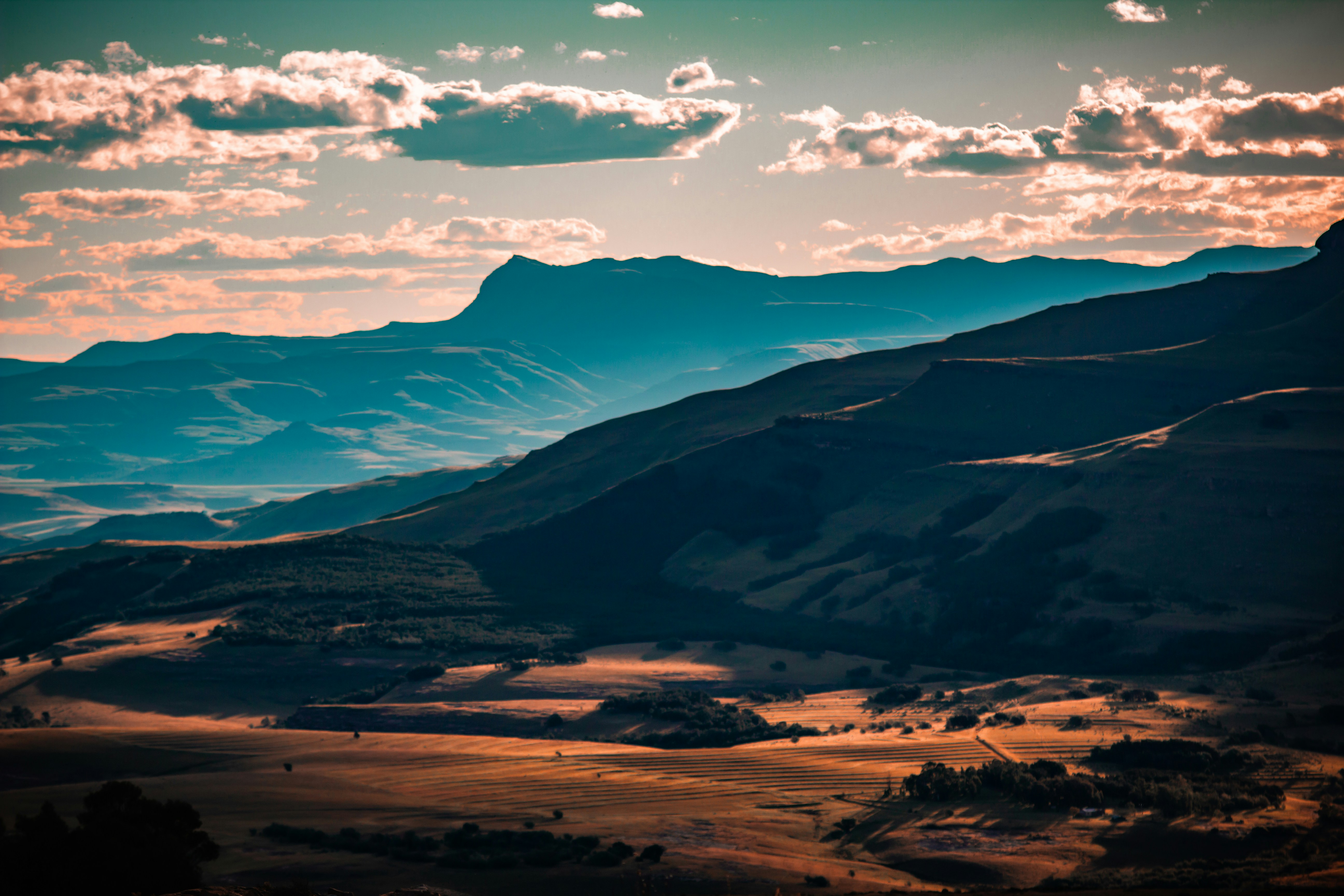 Distant Rim: A Sunset Fold Over Rolling Terrains