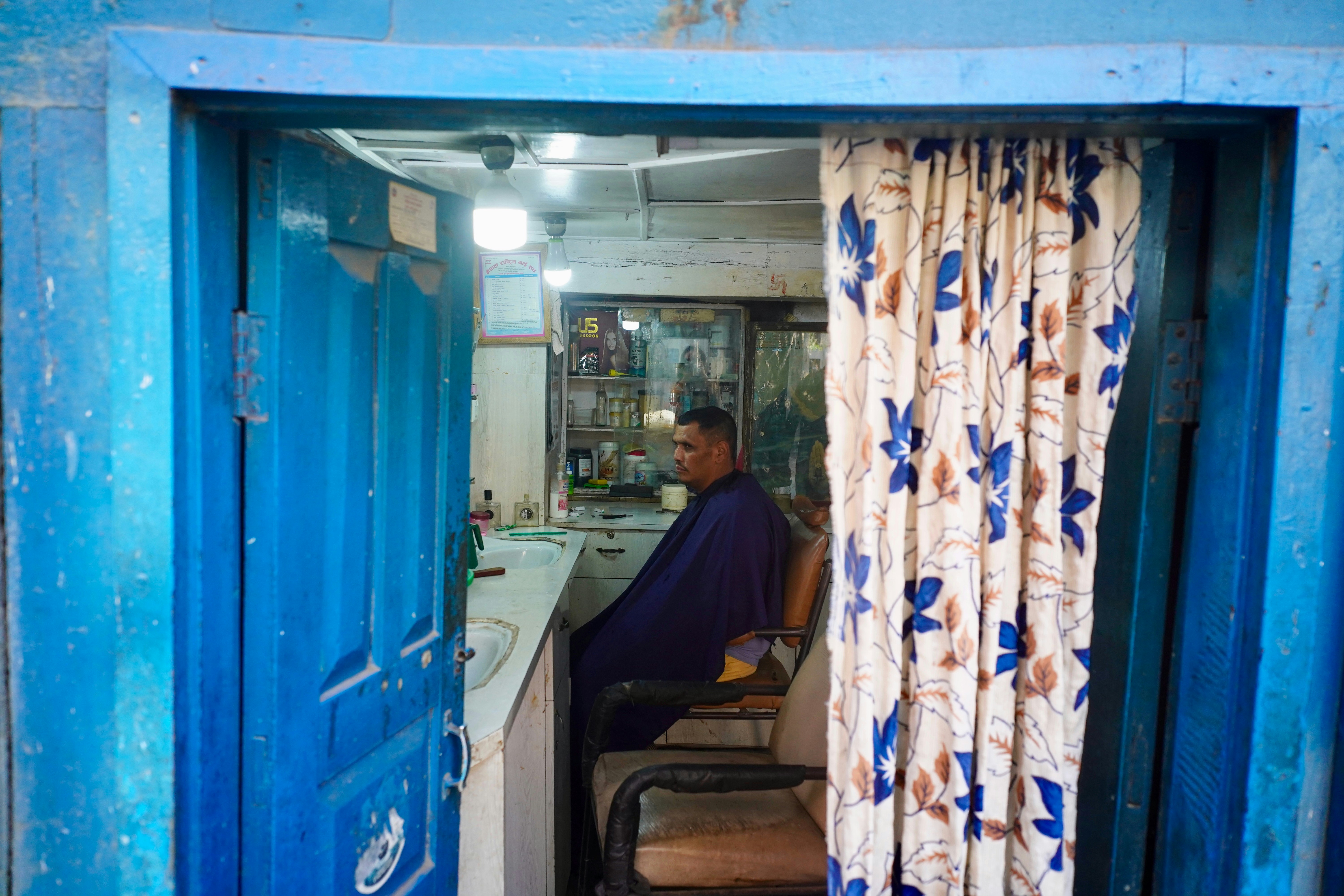 Blue doorway into a barber’s nook: a quiet moment behind the curtain