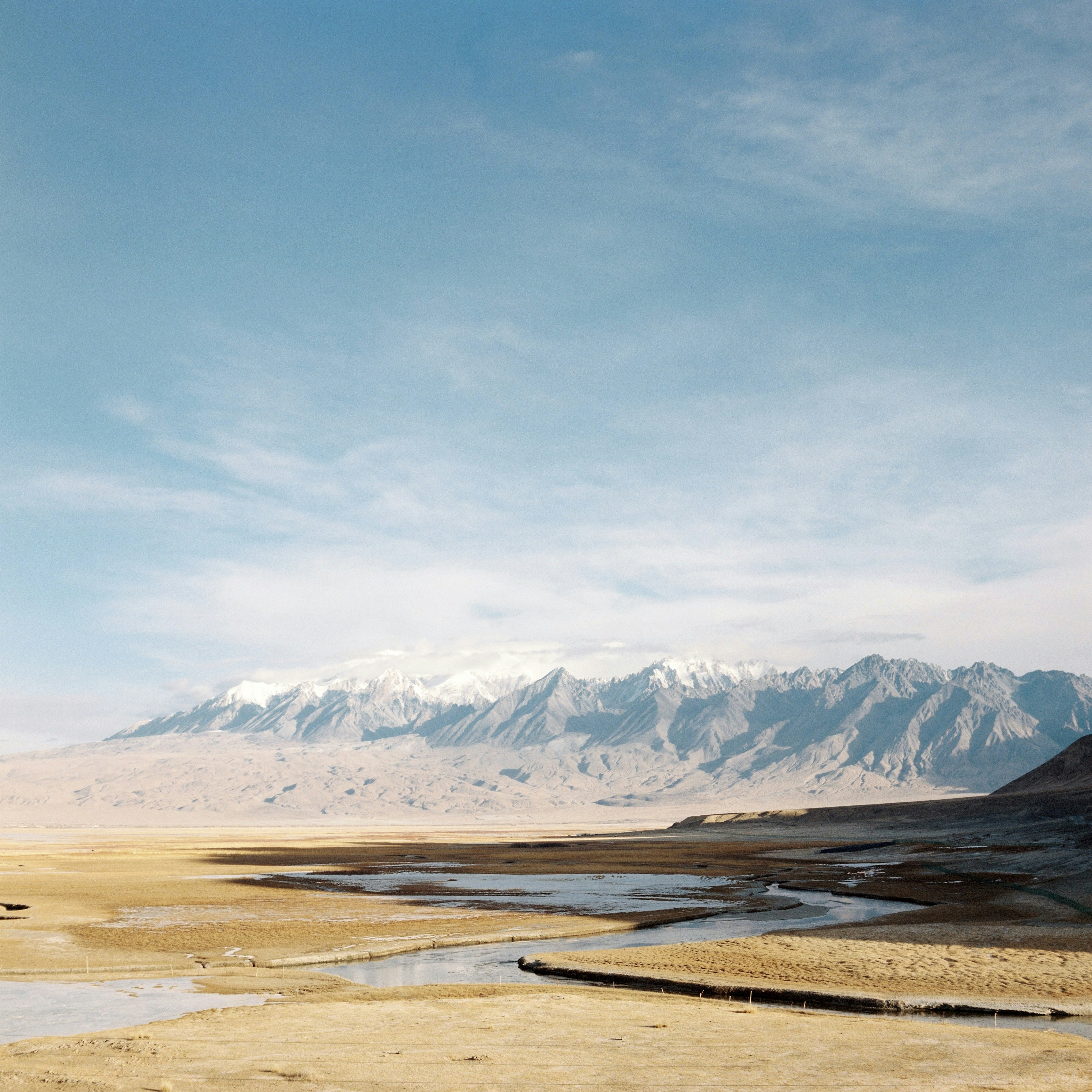 Desert Confluence: Snow-Capped Range Meets Arid Flats