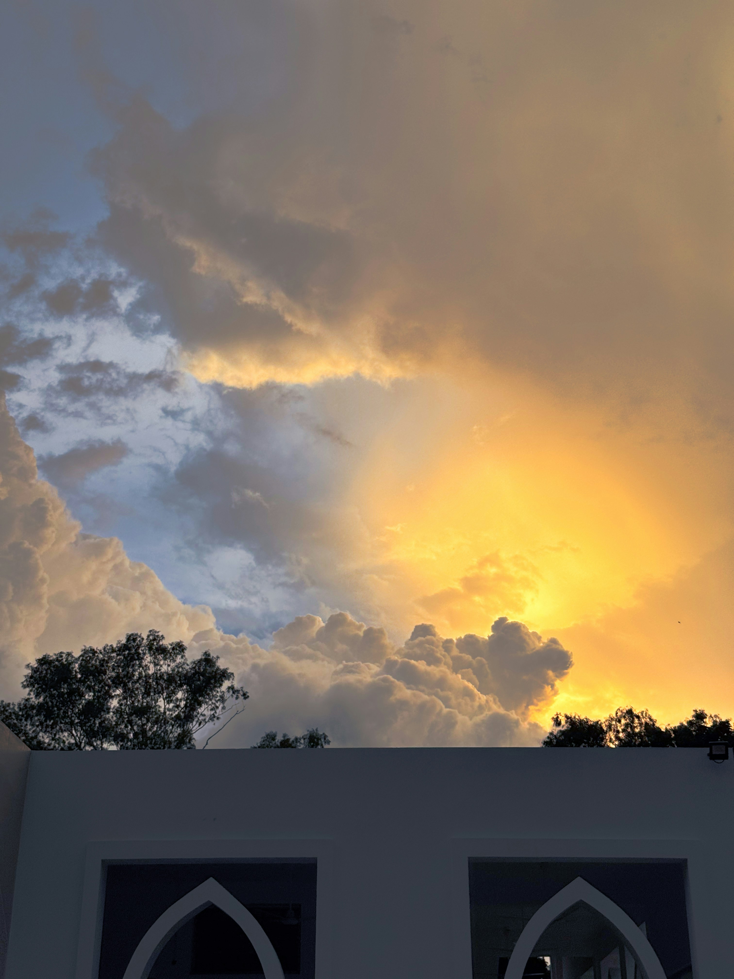 Sunset halo over modern arches