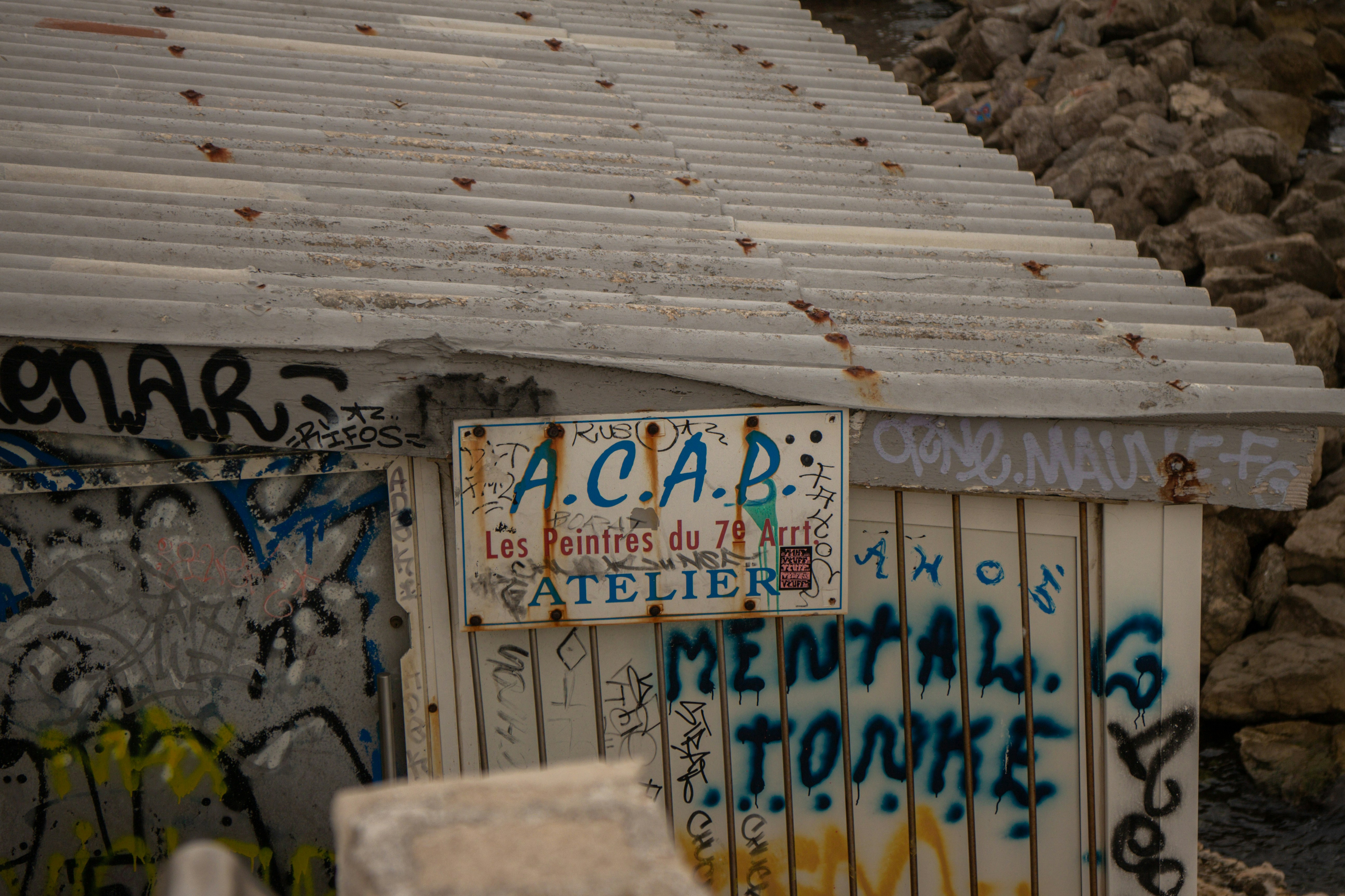 Workshop of Echoes: The Graffiti Atelier Closed Behind a Corrugated Sill