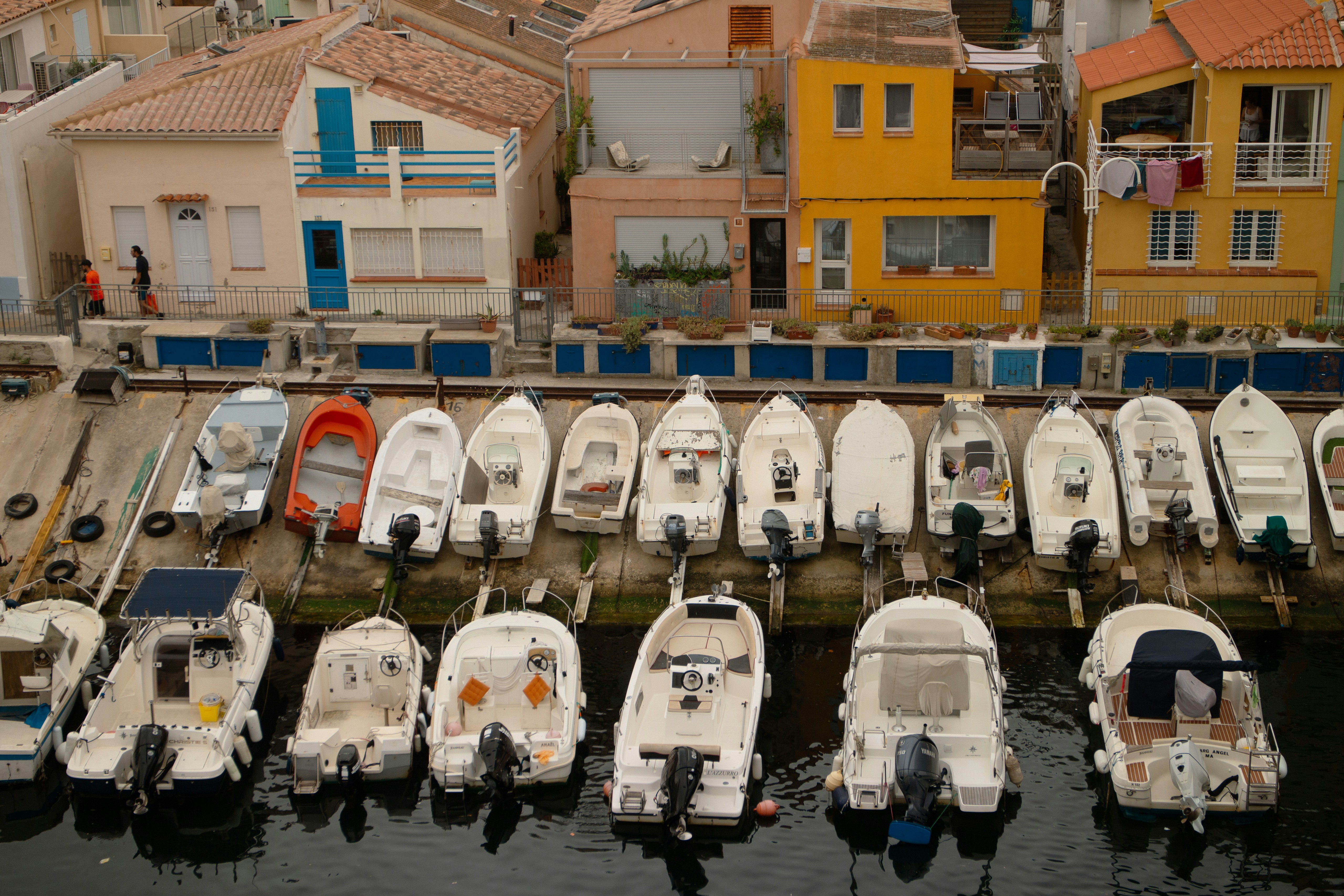 Colorful Boats at a Quiet Canal Amid Coastal Homes