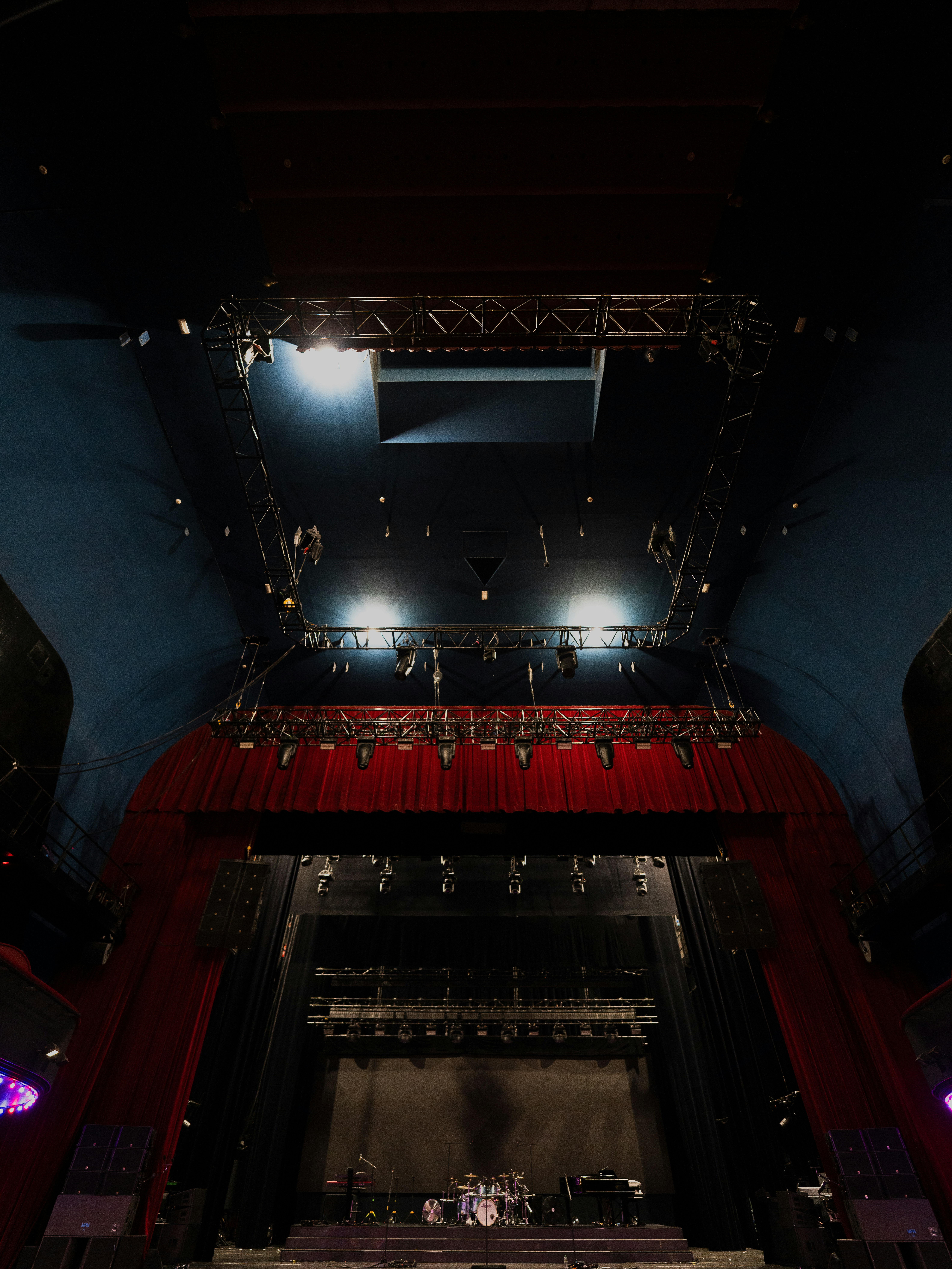 Center Stage: The Empty Concert Hall Embracing Its Red Curtain