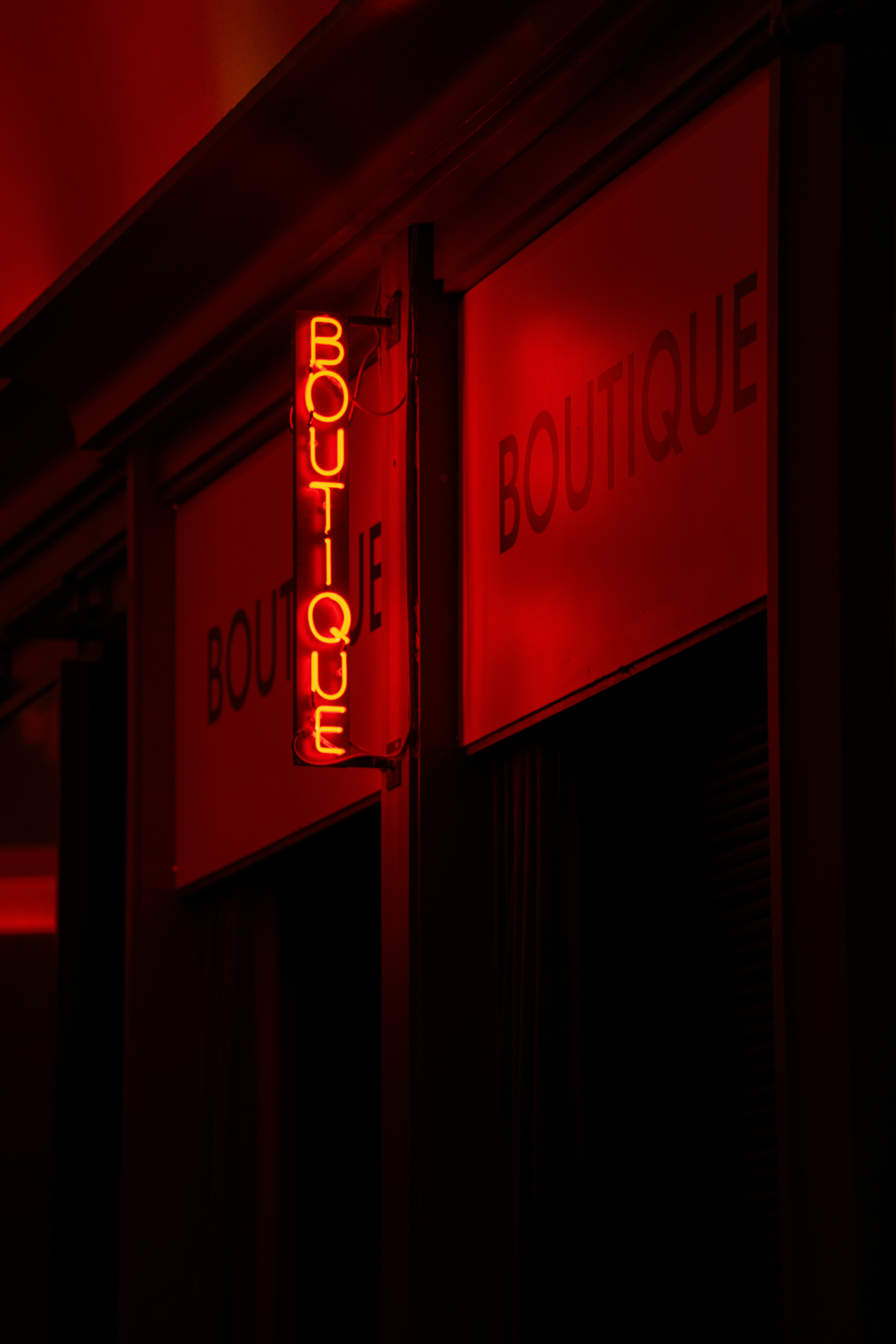 Neon Boutqiue: Red Letters in the Shadowed Entrance
