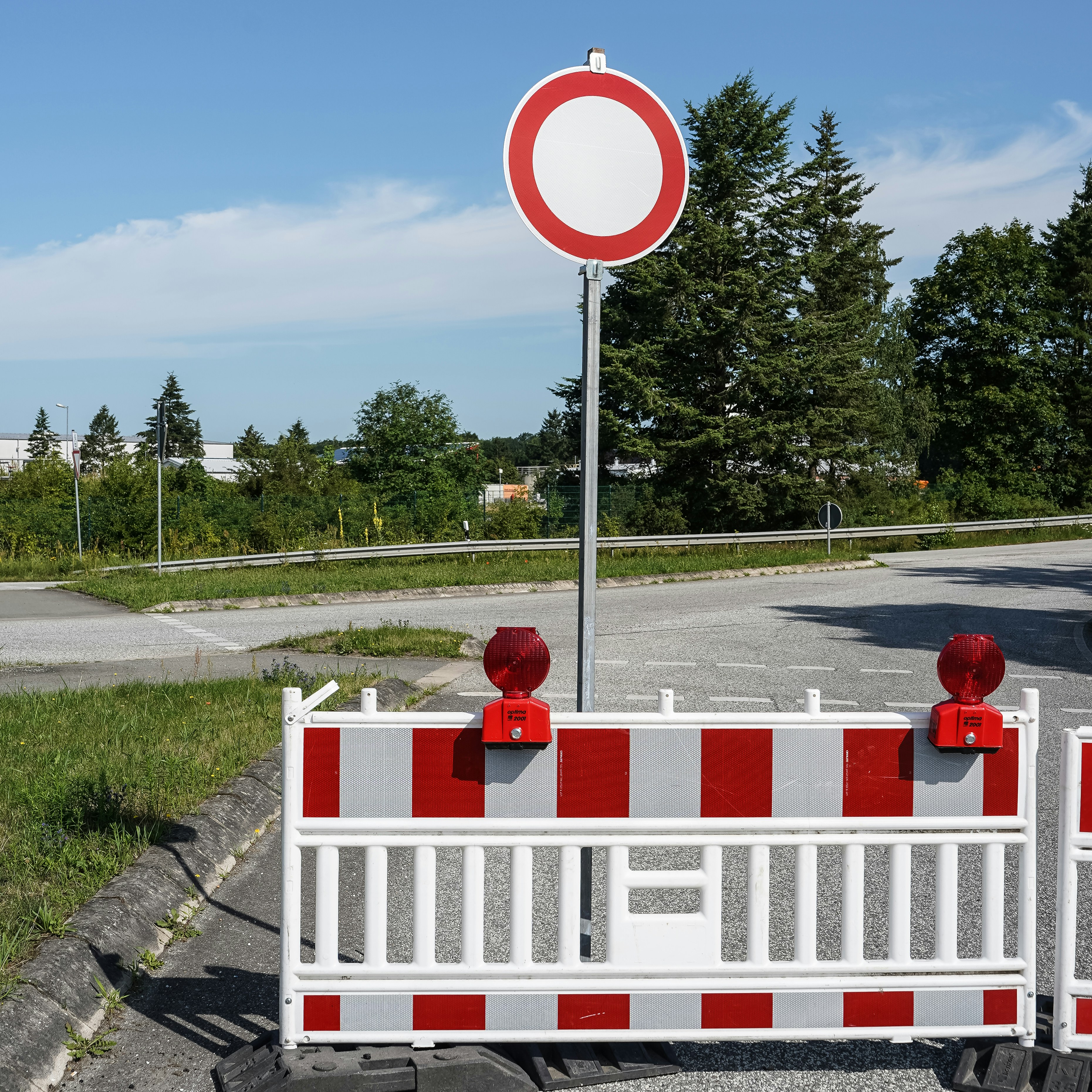 Red-and-white Barrier Guarding an Open Street