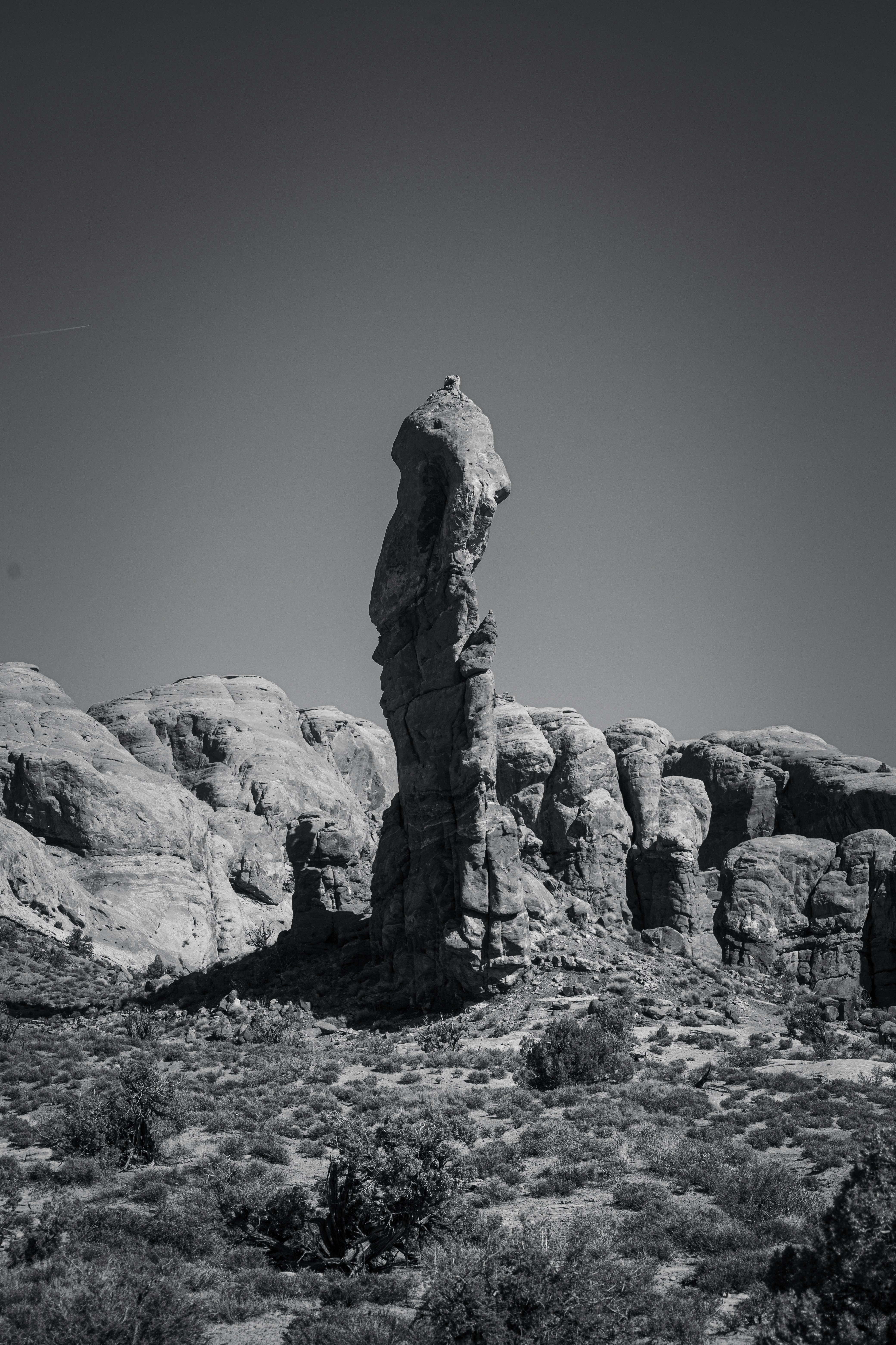 Isolated Sentinel: A Lone Rock Carved into the Desert Sky