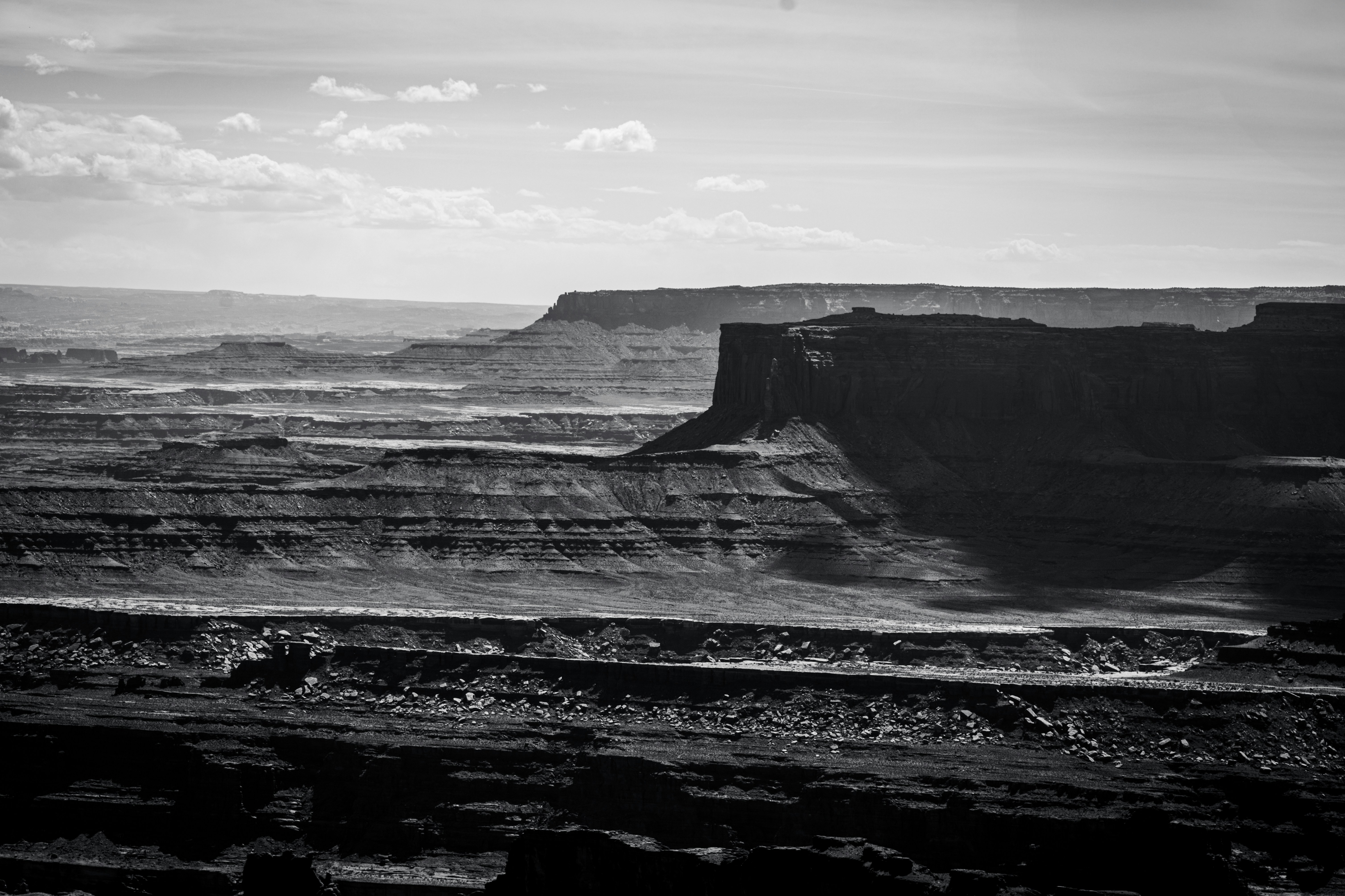 Erosion’s Edge: Stratified Cliffs Under Broad Sky