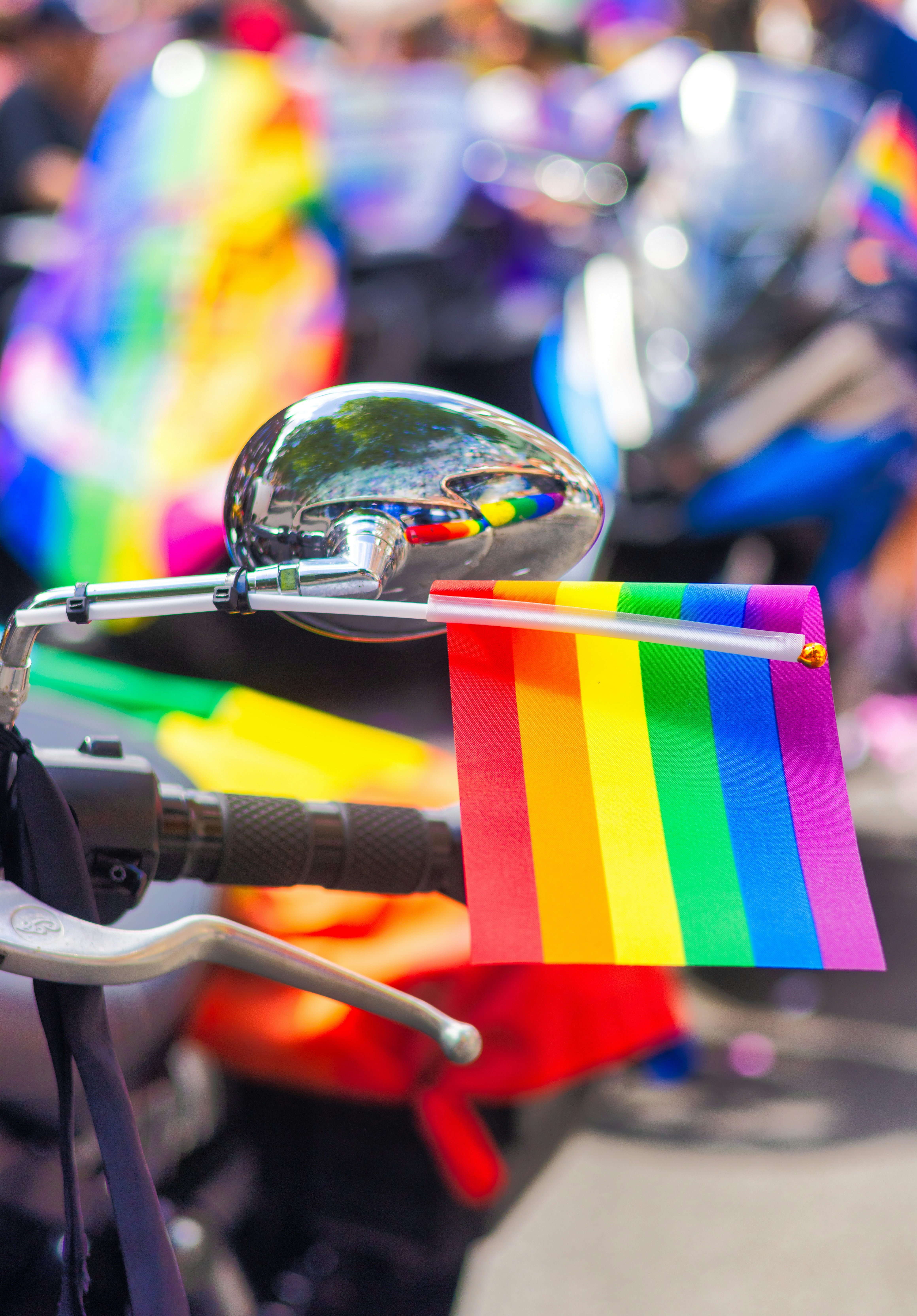 Rainbow Pride Flag Reflections on a Motorcycle Mirror