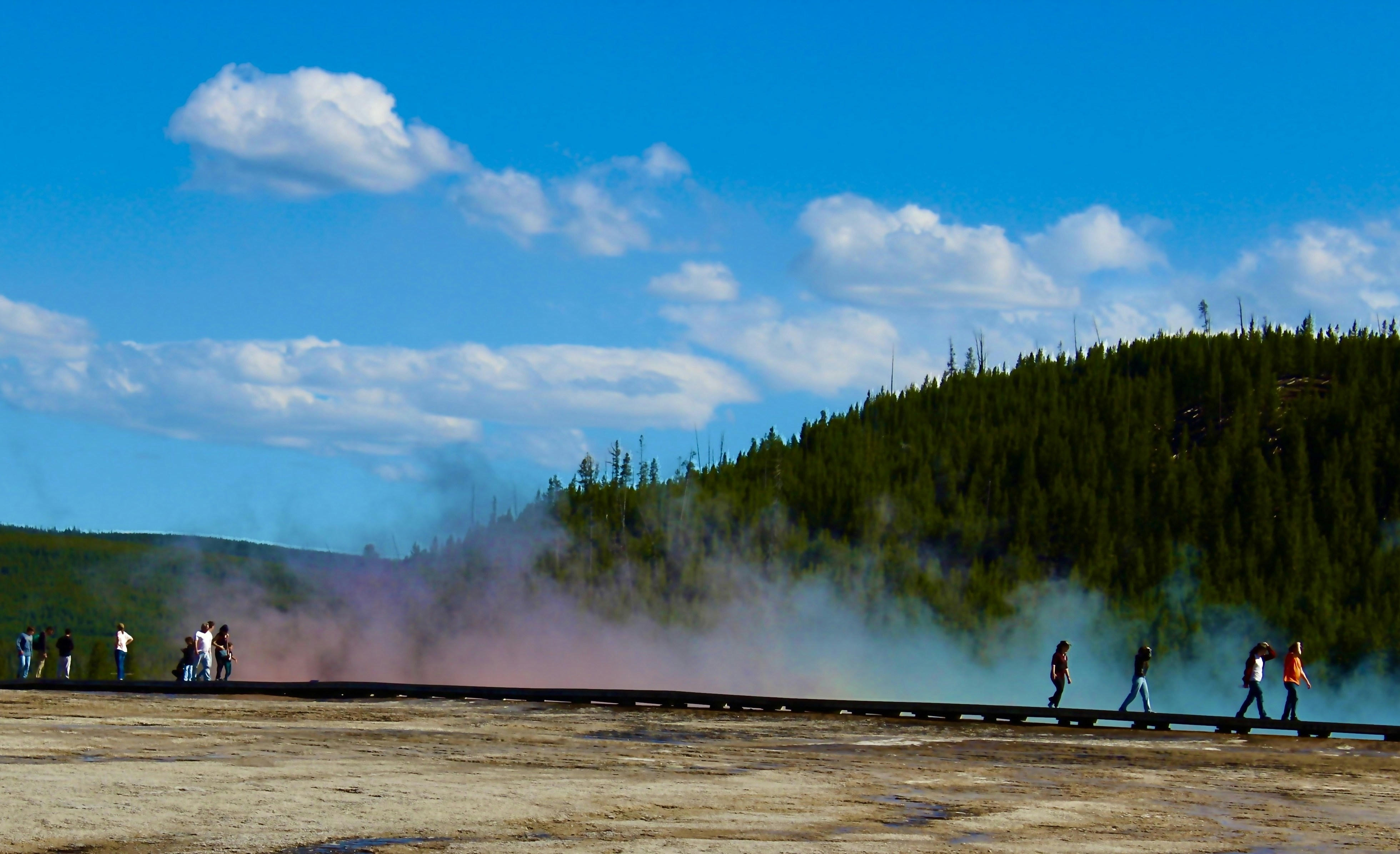 Steam on the Boardwalk: Tourists Crossing a Thermal Path