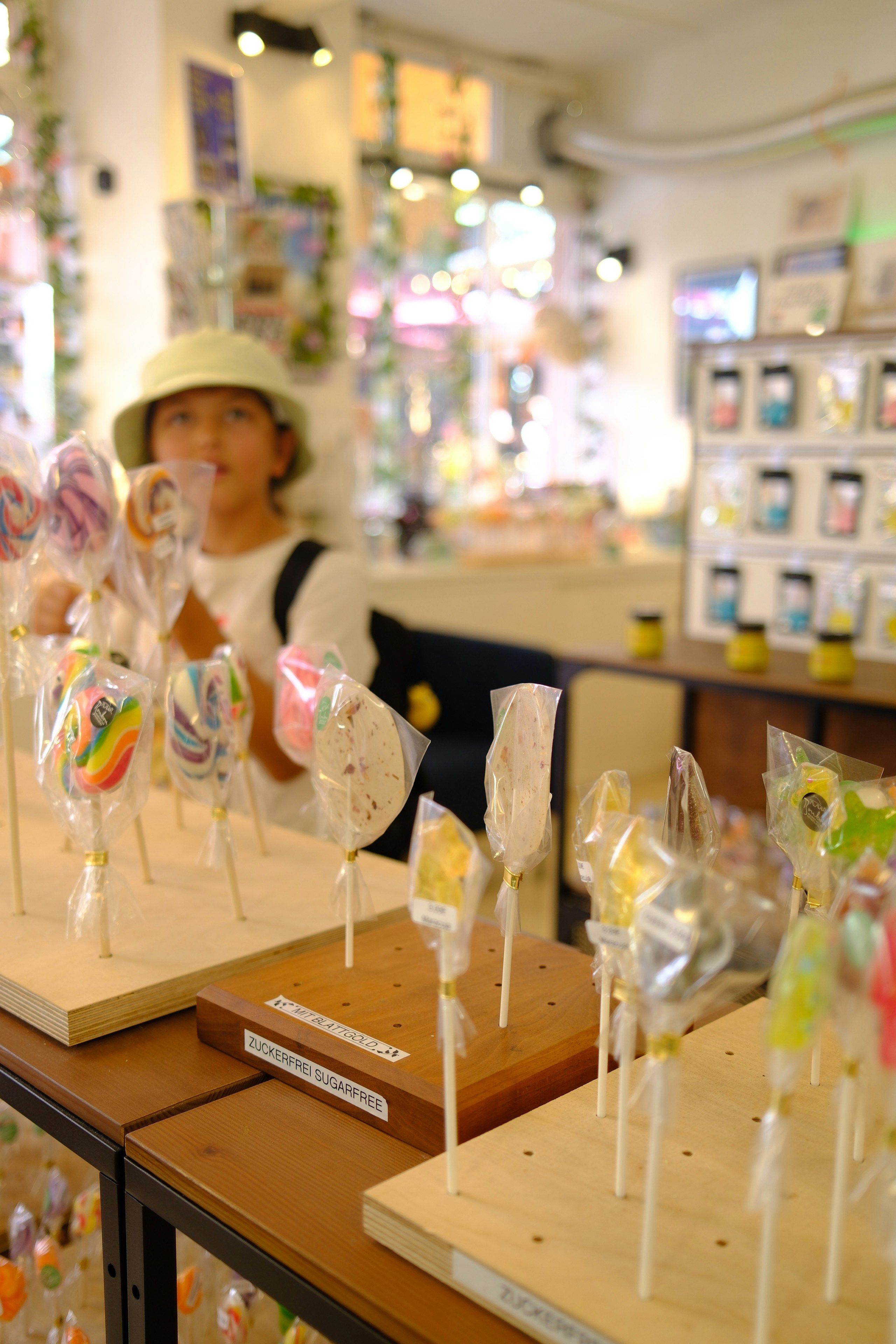 Candy Shop Portrait: Blurred Treats and a Soft-Focused Visitor