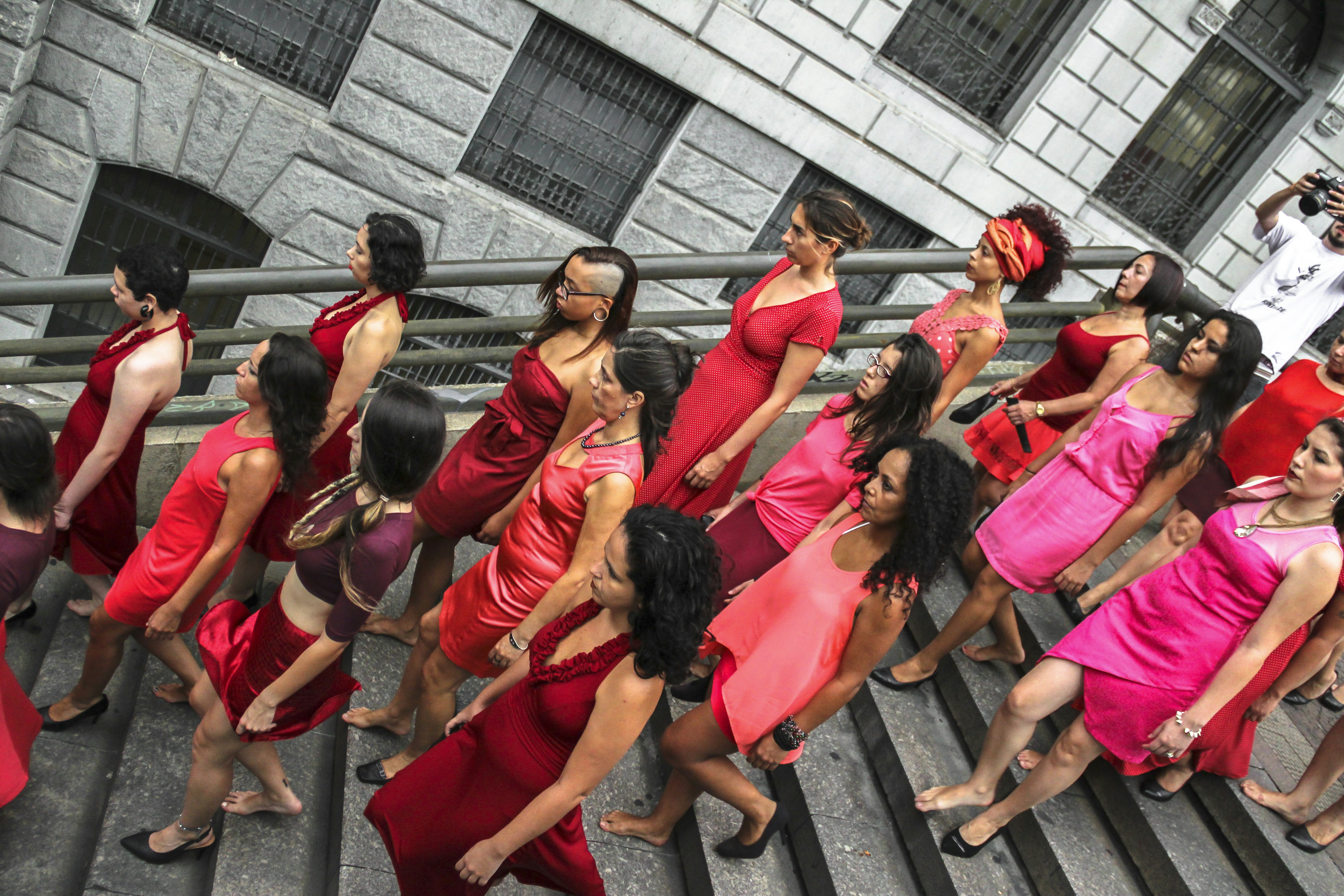 Scarlet Chorus: A Line of Red Dresses Descends the City Steps