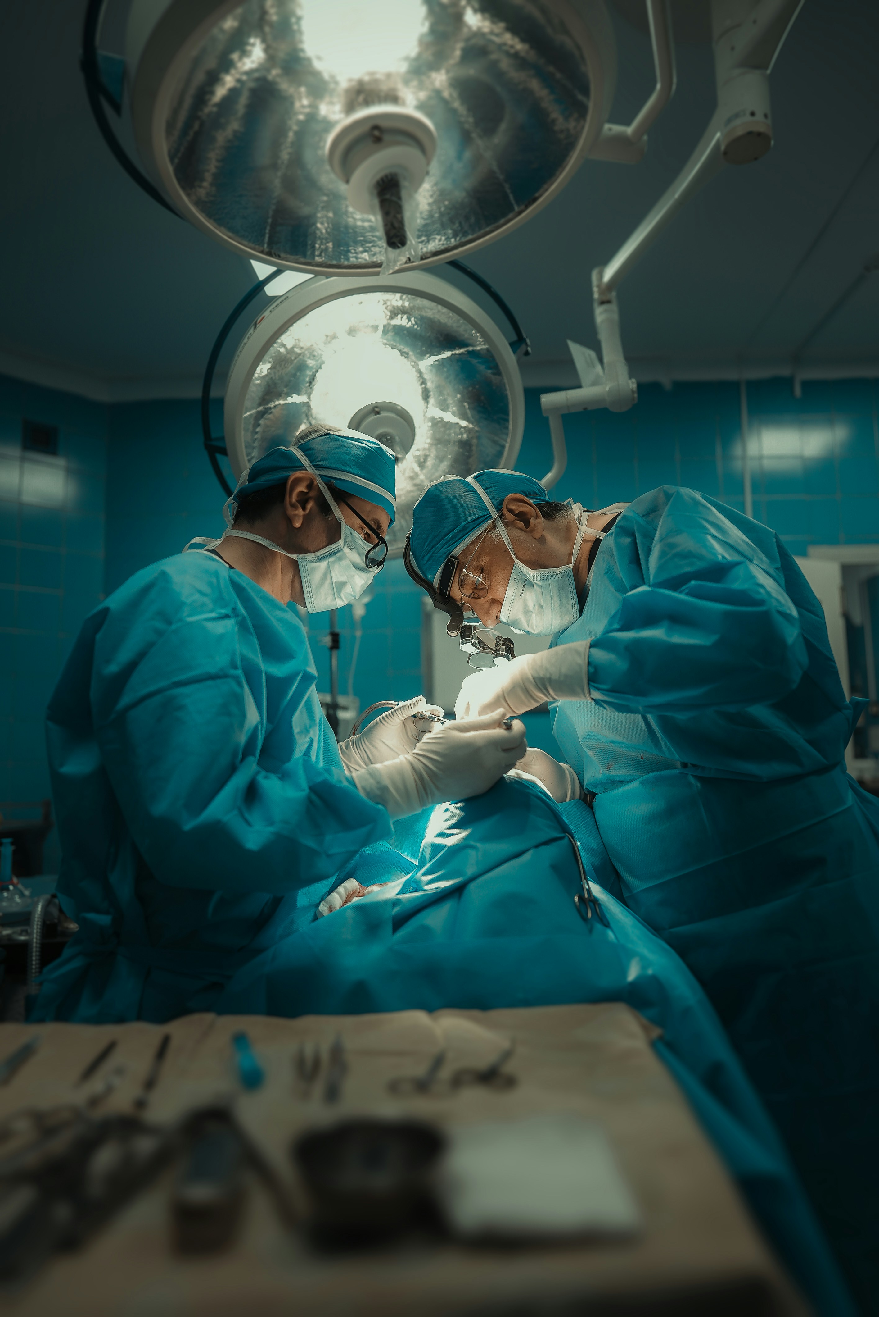 Under the Lights: Surgeons in blue guarding a careful dawn of healing