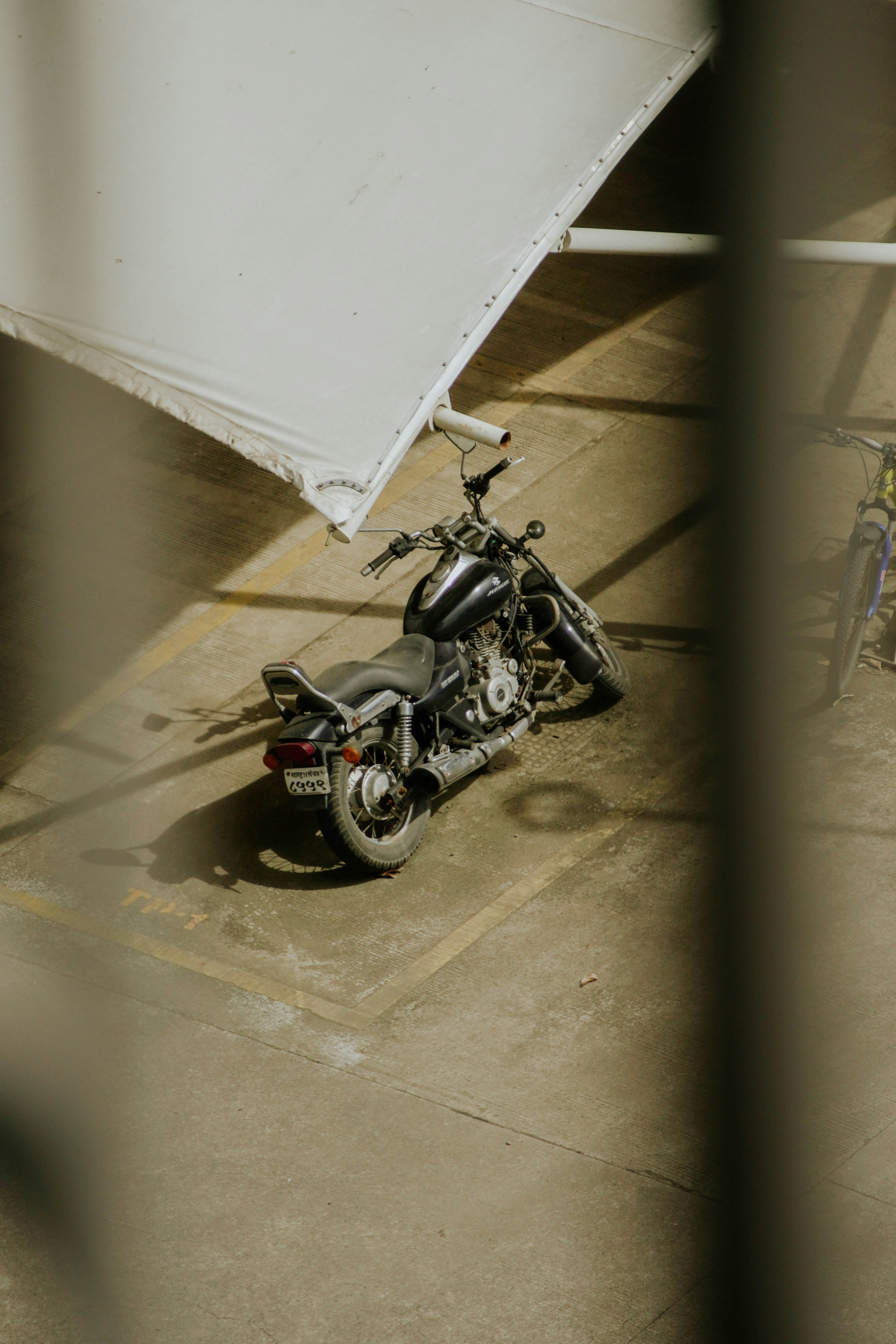 Motorcycle Beneath a Canopy: Hidden by Gratings