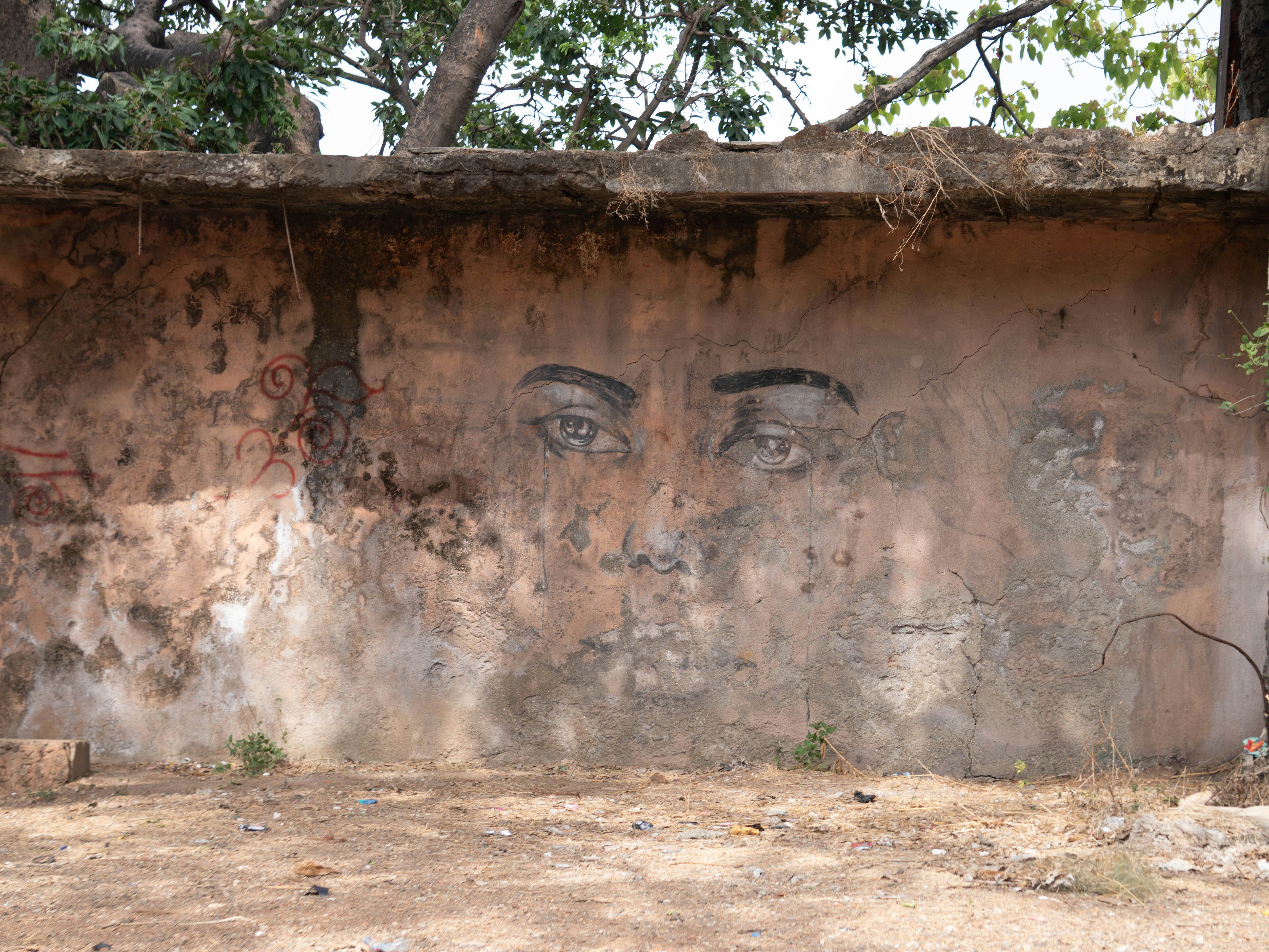 Eyes in the Cracked Wall: A Mural of Quiet Watchful Gaze