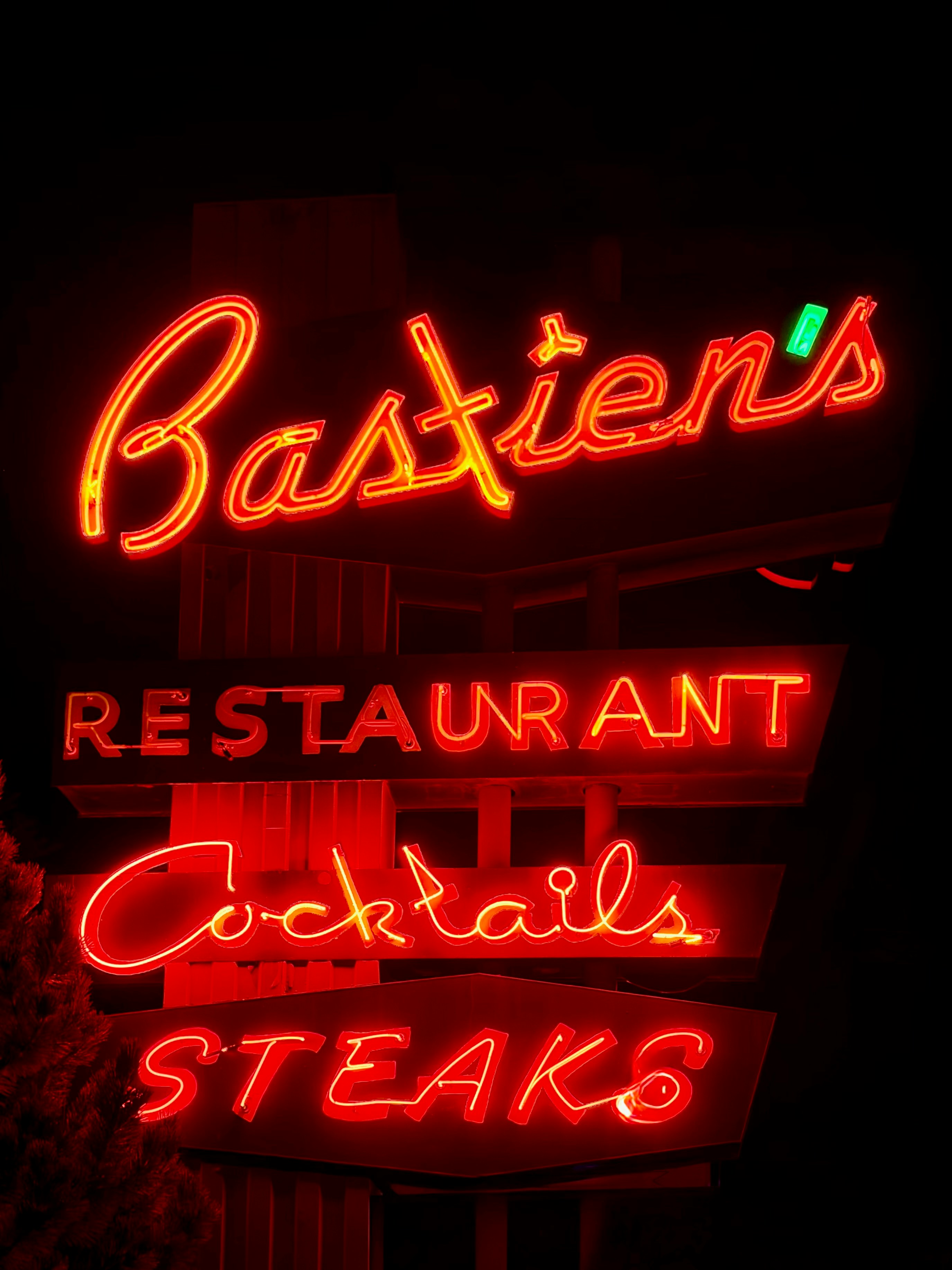 Neon Nights: Batten’s Restaurant Sign Illuminates a Dark Street