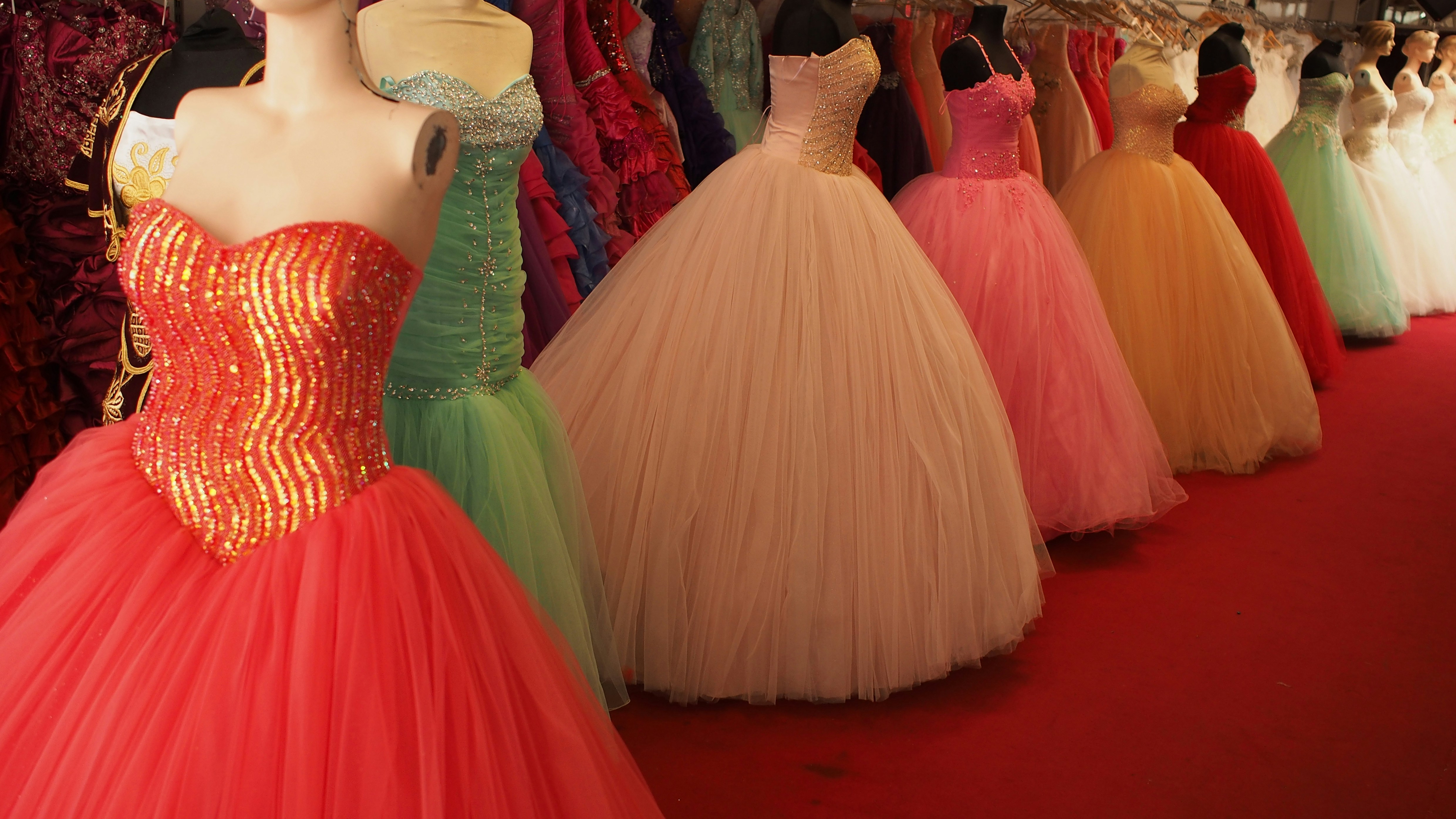 Row of Velvet Dreams: Tulle Gowns on a Crimson Runway