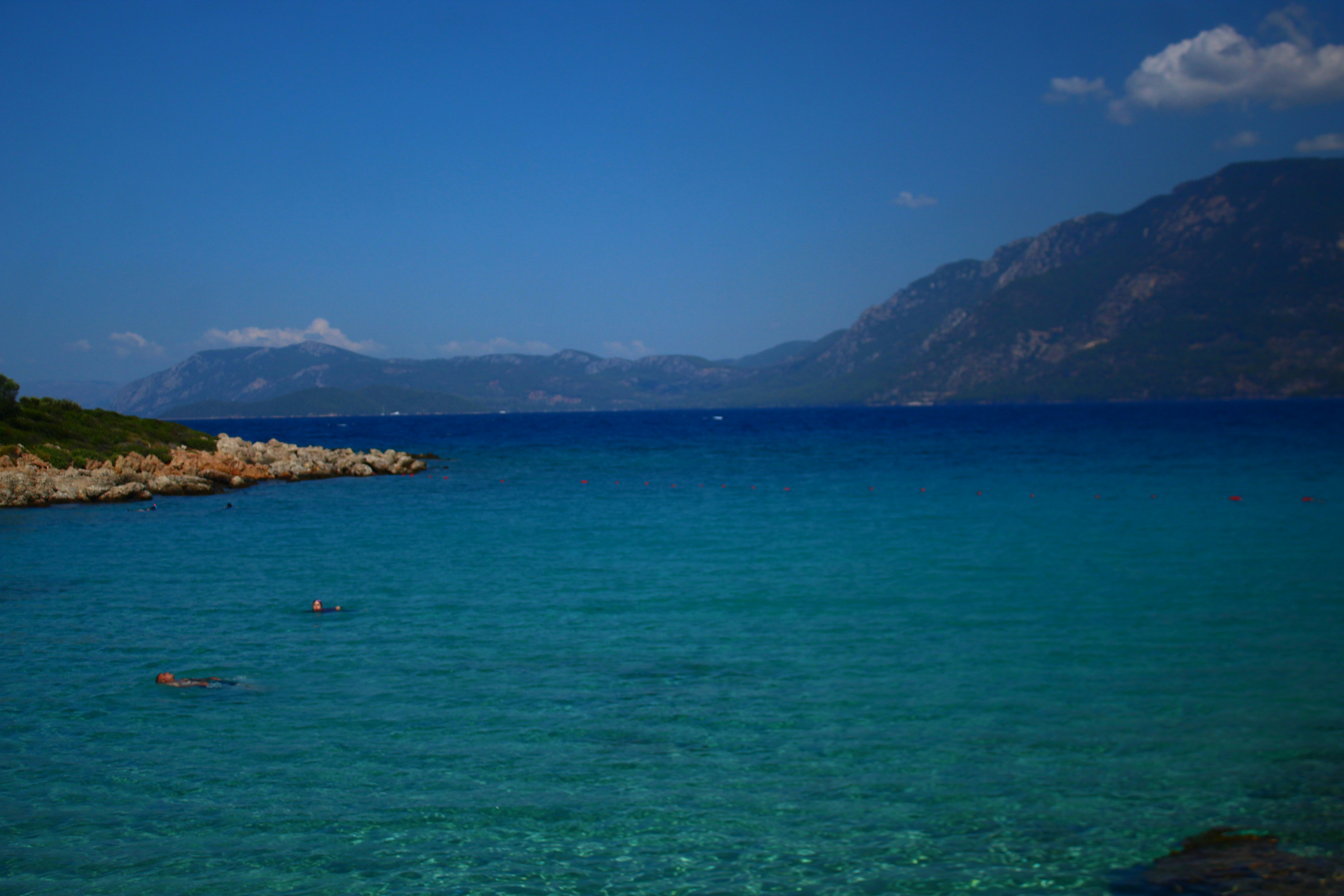 Azure Quiet: Shoreline Light and Distant Mountains