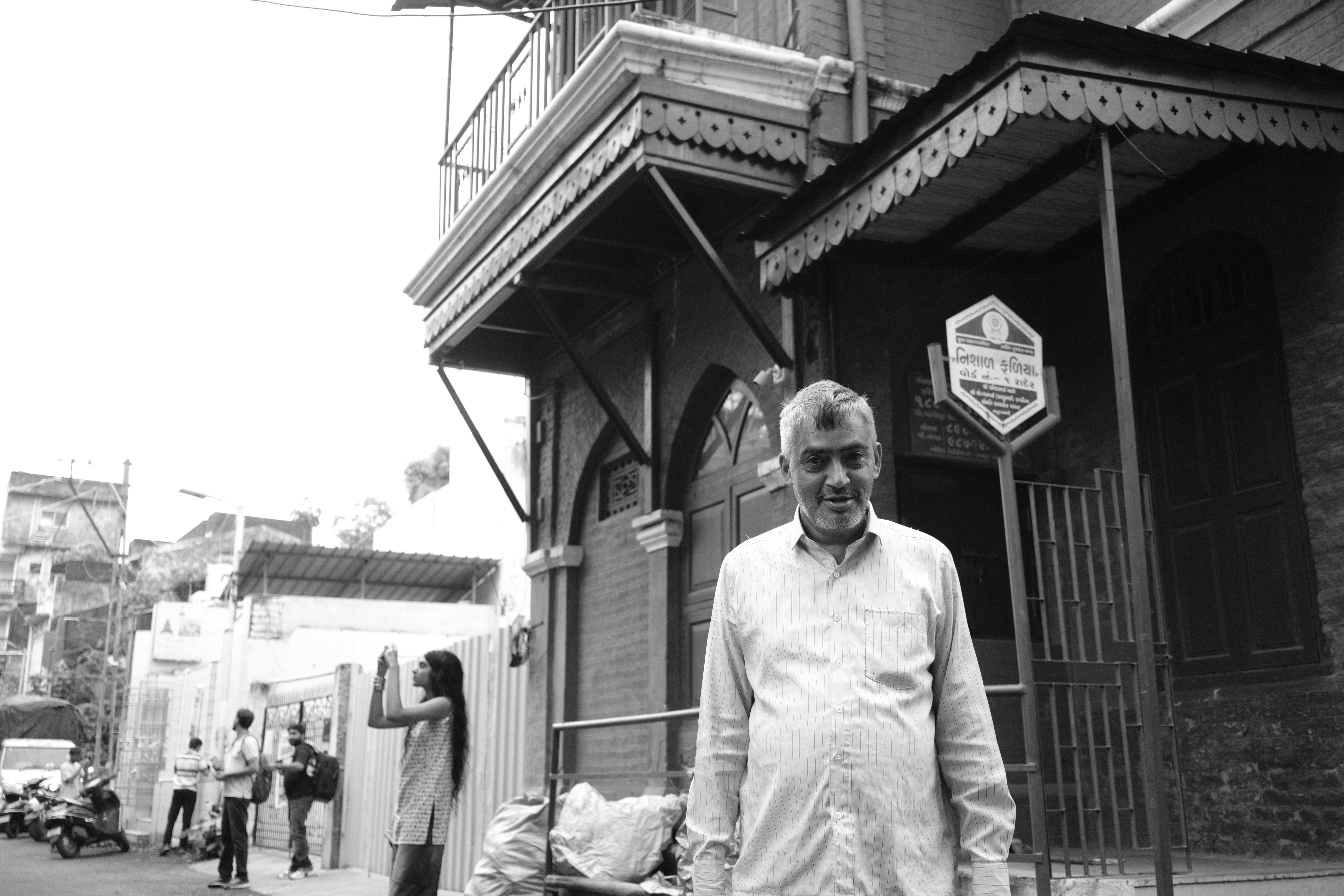 Street Portrait with a Gently Framed Figure at a Cornered Building